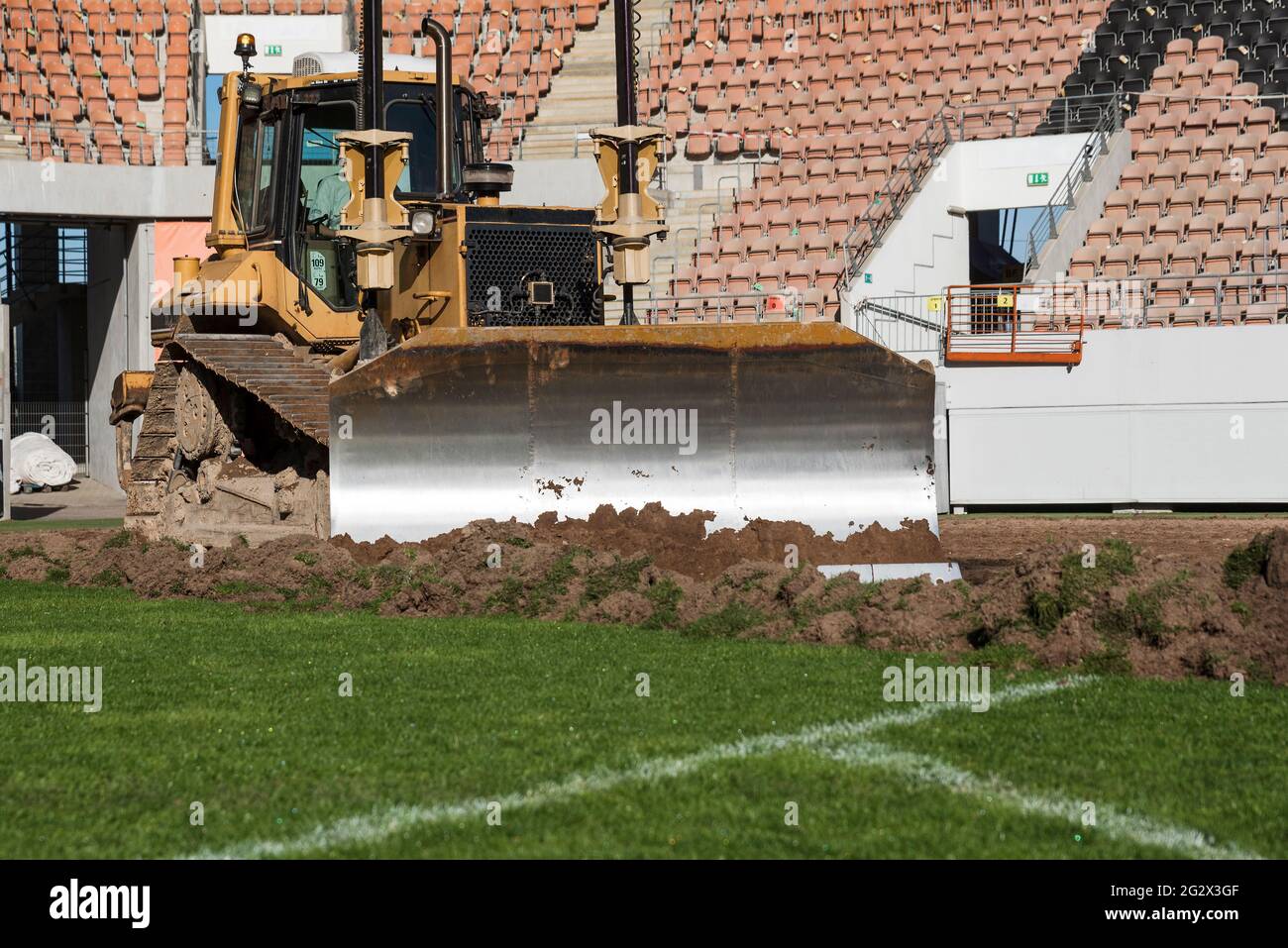 A bulldozer removes turf on a soccer field Stock Photo - Alamy