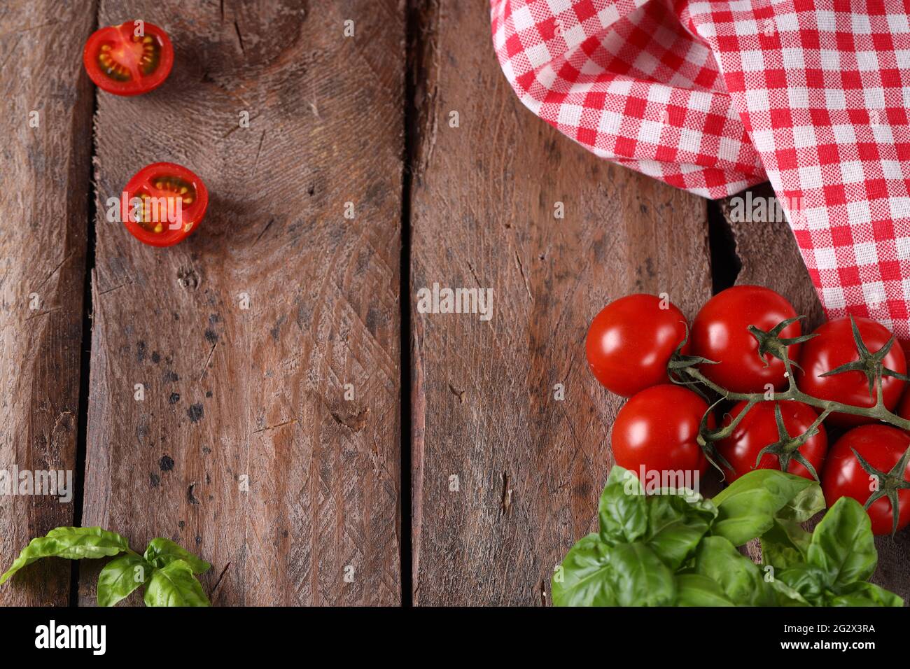 wooden food background with tomatoes and basil Stock Photo - Alamy