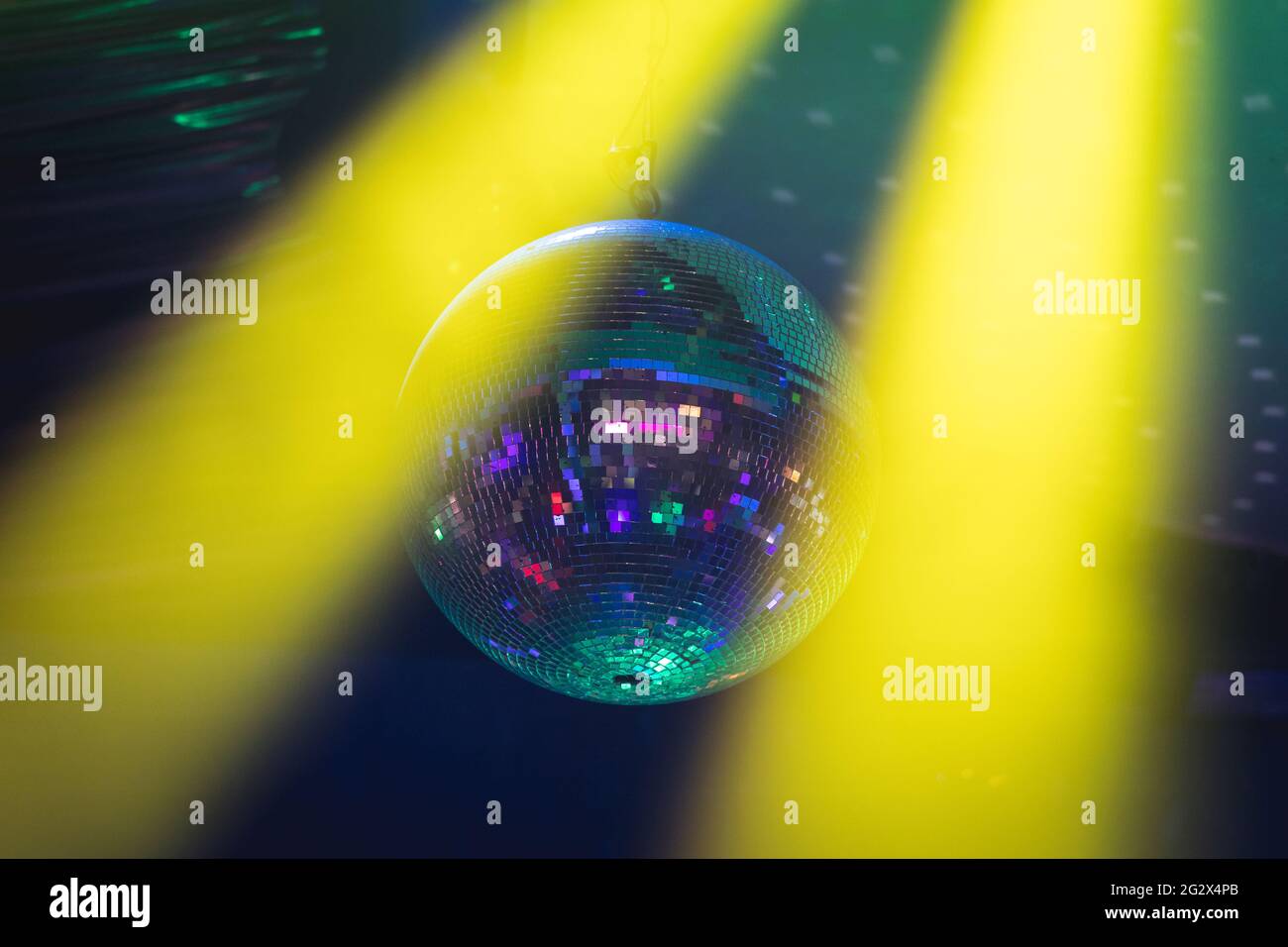 Disco ball and yellow light rays Stock Photo - Alamy