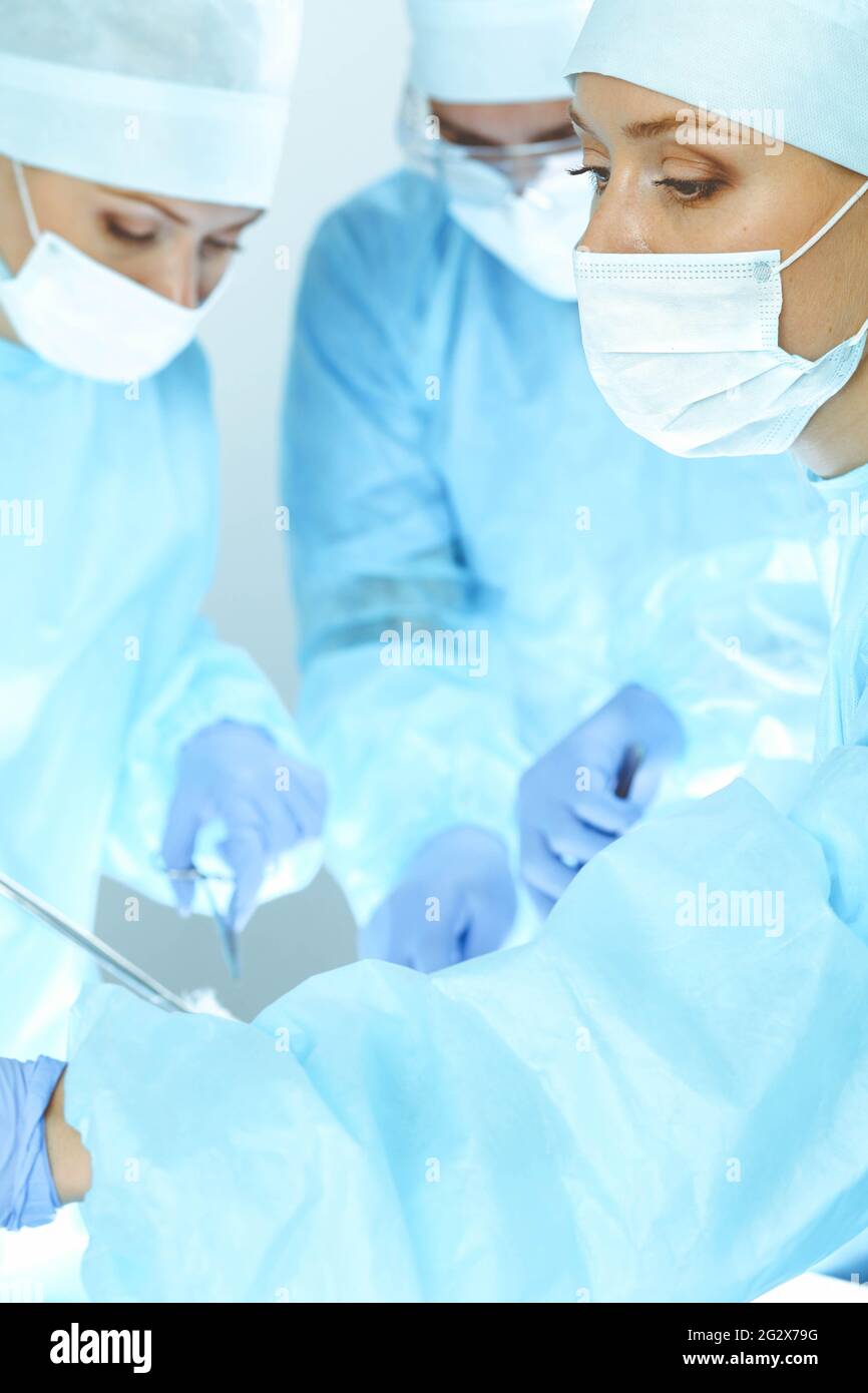 A group of surgeons is operating at the hospital. Health care concept ...