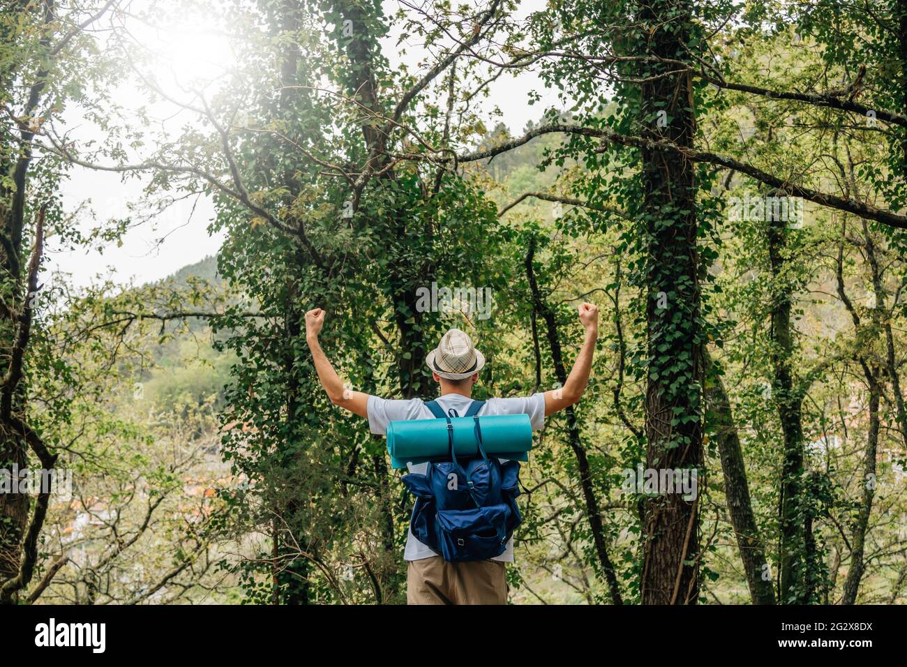 man with backpack in nature with arms raised Stock Photo - Alamy