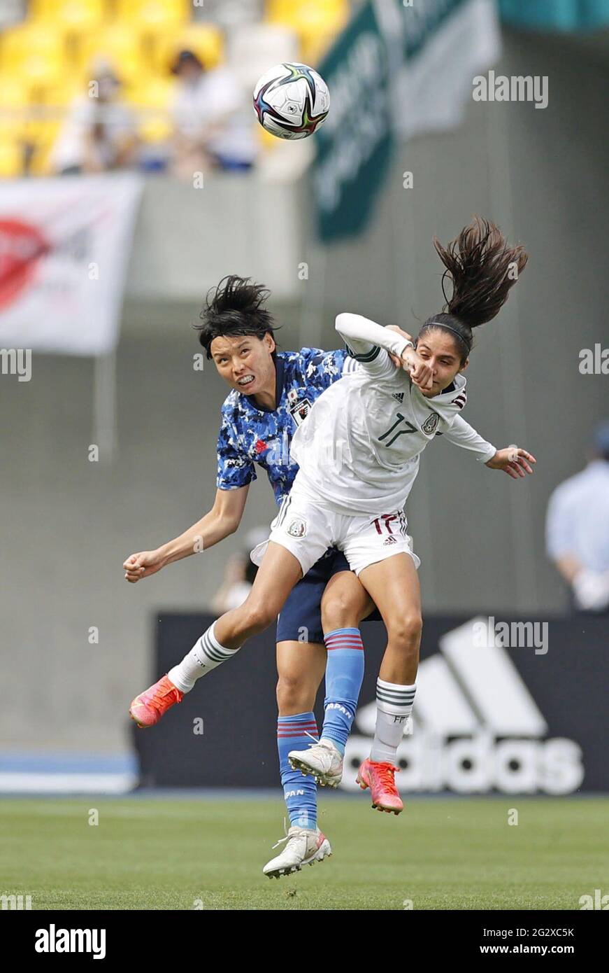 Saki Kumagai (L) of Japan and Alison Gonzalez of Mexico vie for the ball in the second half of ...