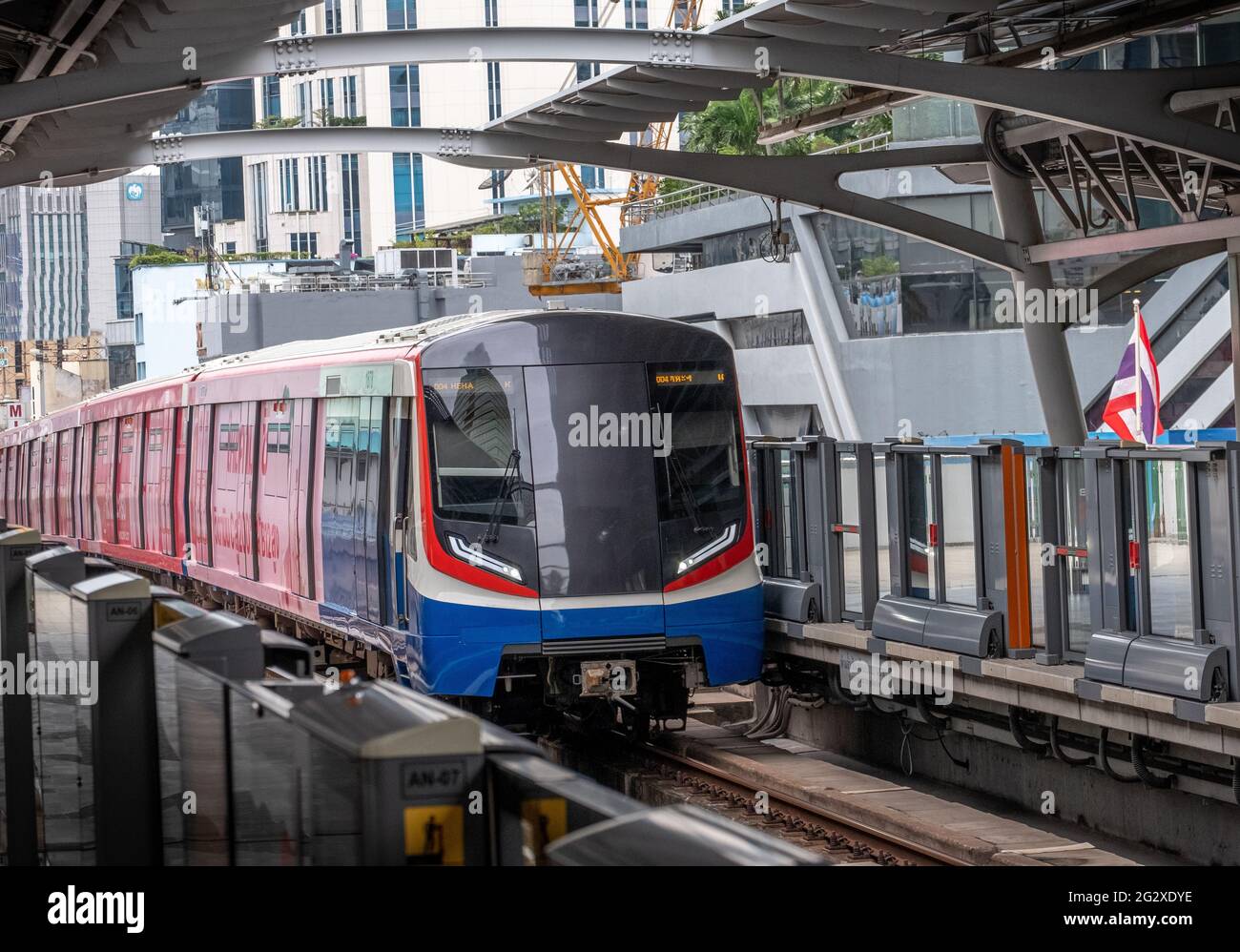 Bangkok’s BTS sky train pulling into a station in the downtown area ...