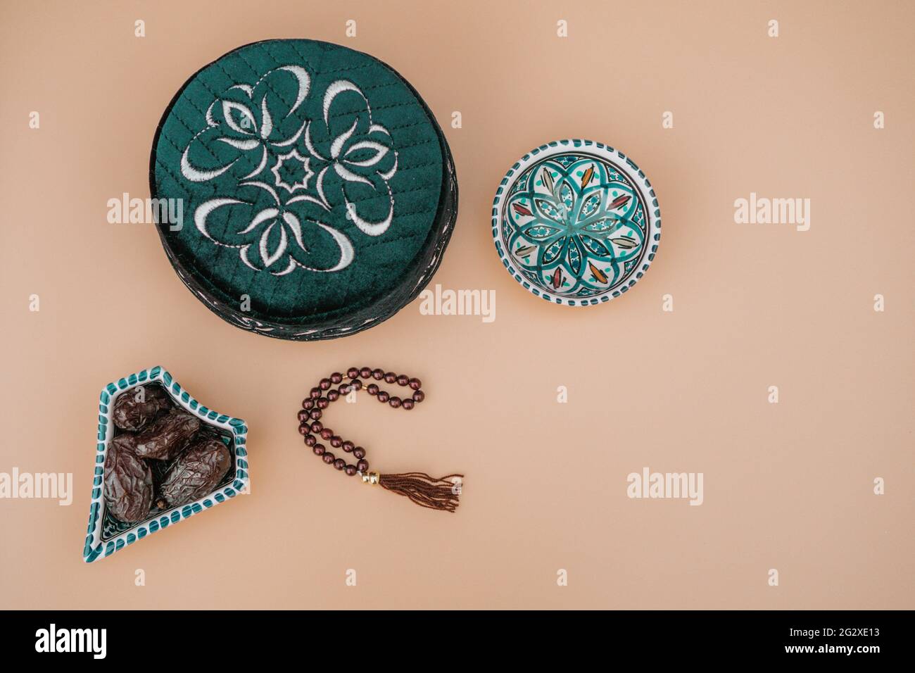 Muslim islamic faith concept taqiyah skullcap , red rosary, dates in ...
