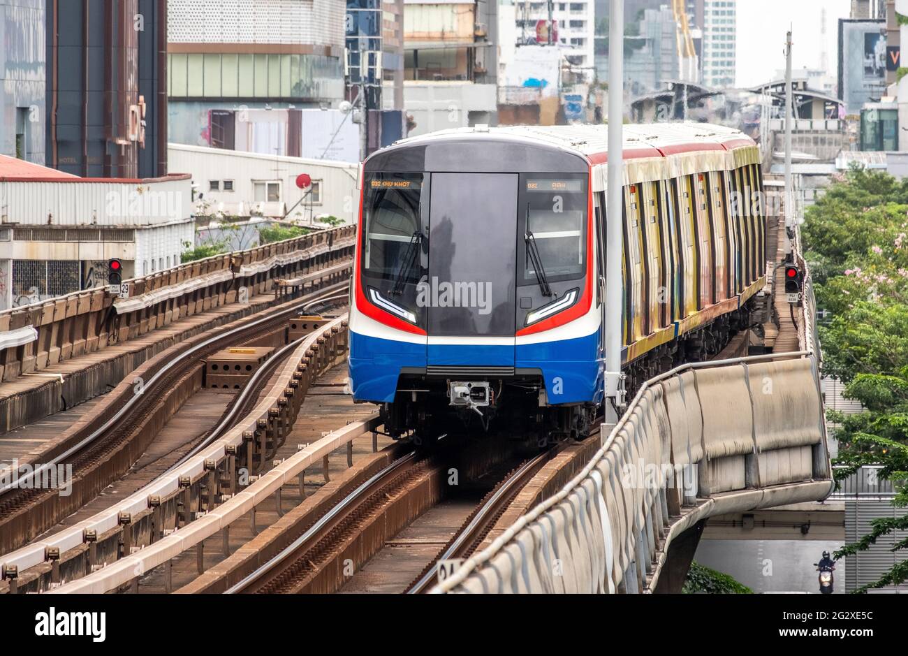 Bangkok’s BTS sky train pulling into a station in the downtown area ...
