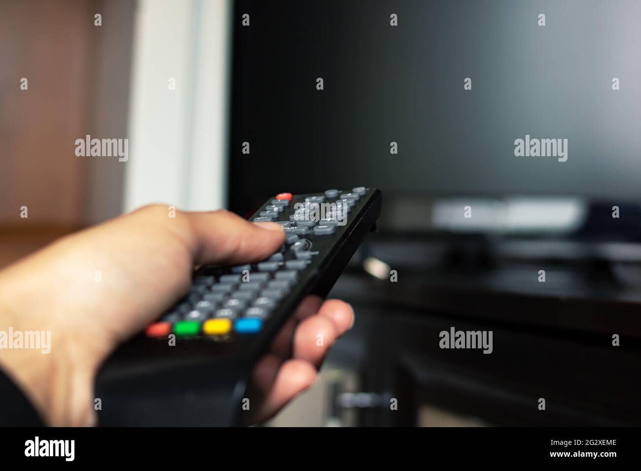 Tv remote in hand hi-res stock photography and images - Alamy