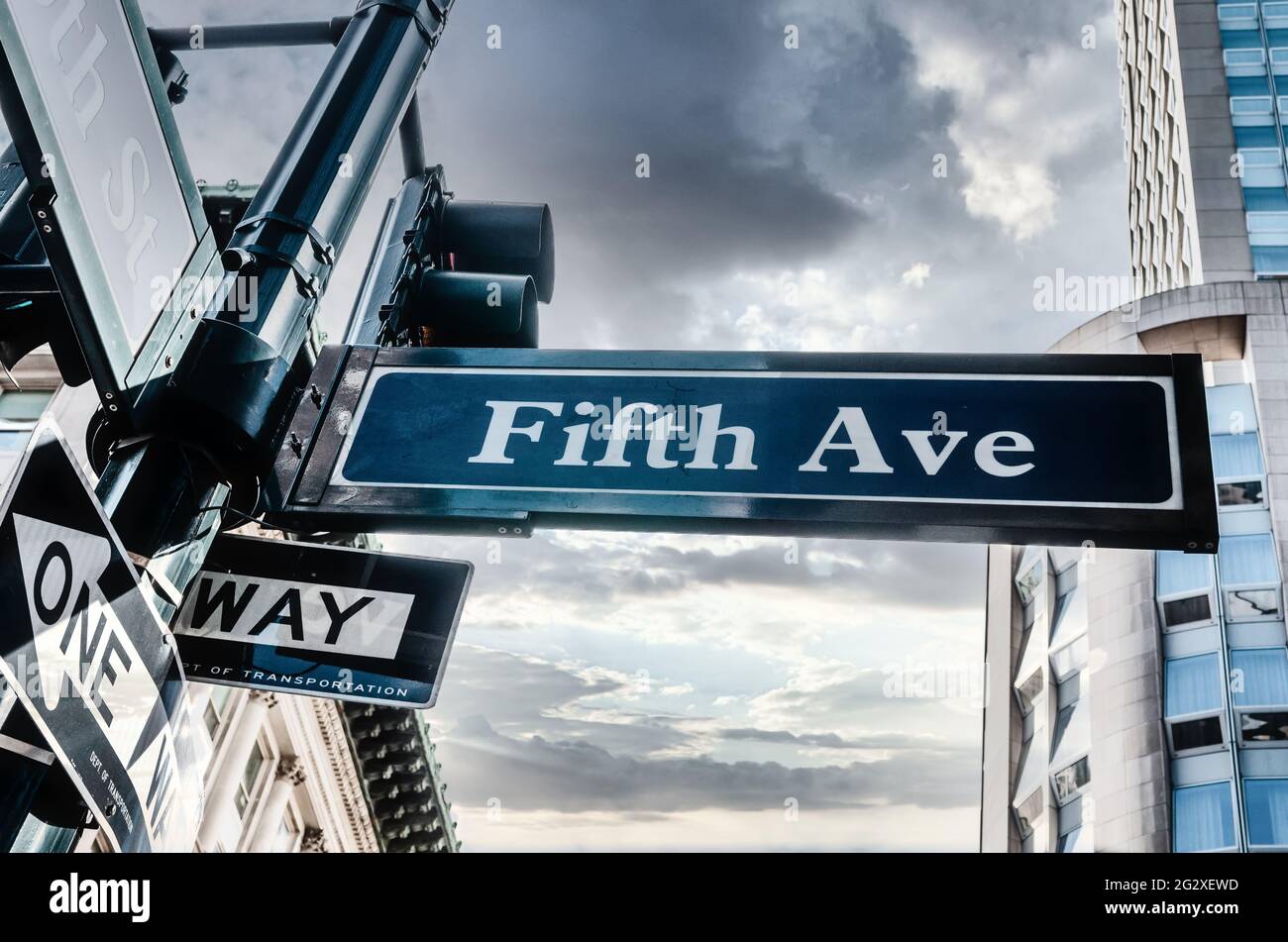Blue Fifth Ave Sign with cloudy skiy, low angle in New York, USA Stock ...