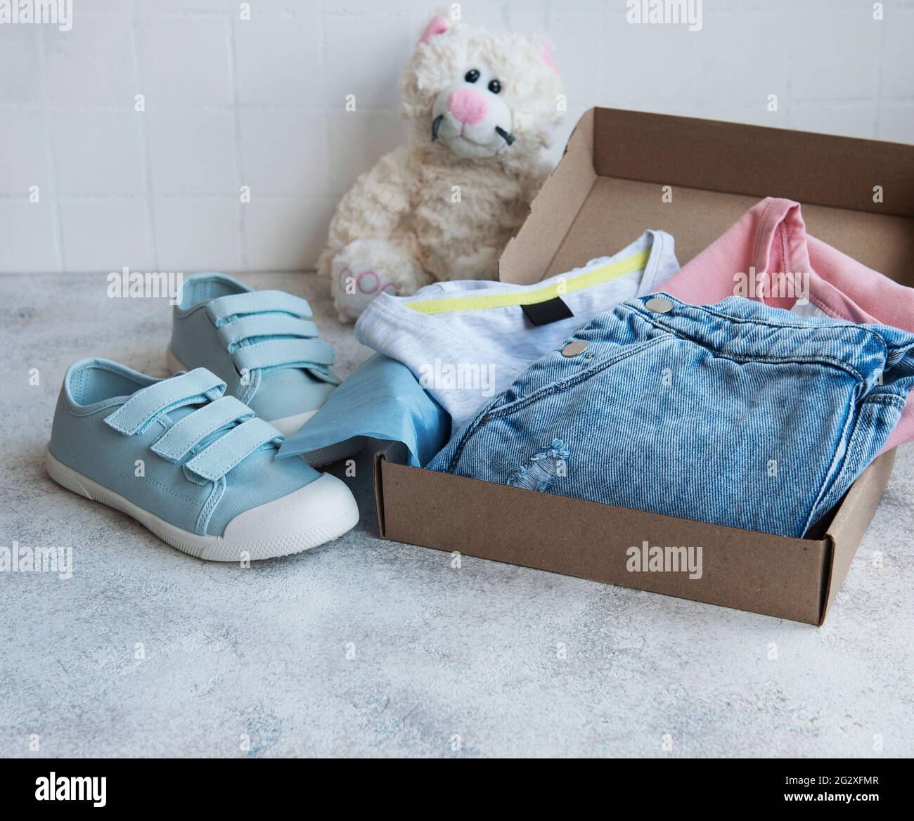 Clothes for kids in an open cardboard box. Online shopping concept ...