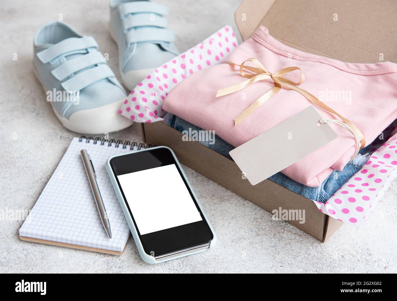 Clothes for kids in an open cardboard box. Online shopping concept ...