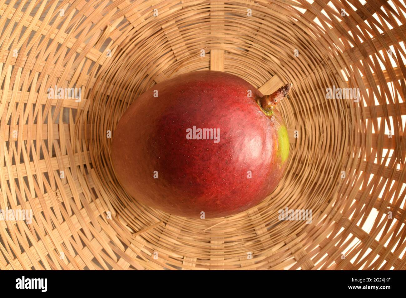 Juicy mango in a bowl of wicker vine, close-up, top view Stock Photo ...