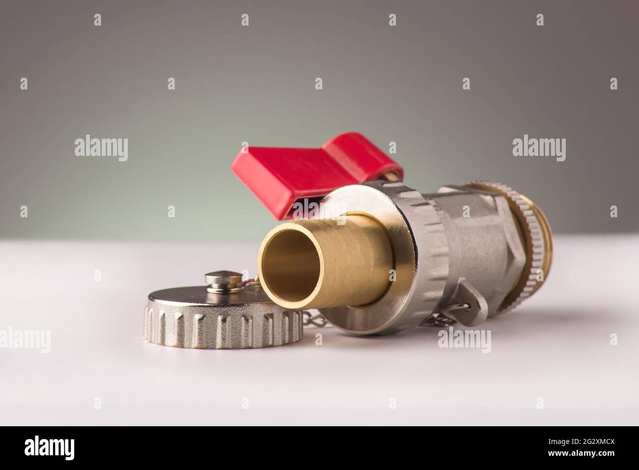 Water discharge tap with red handle for water close-up on isolated ...