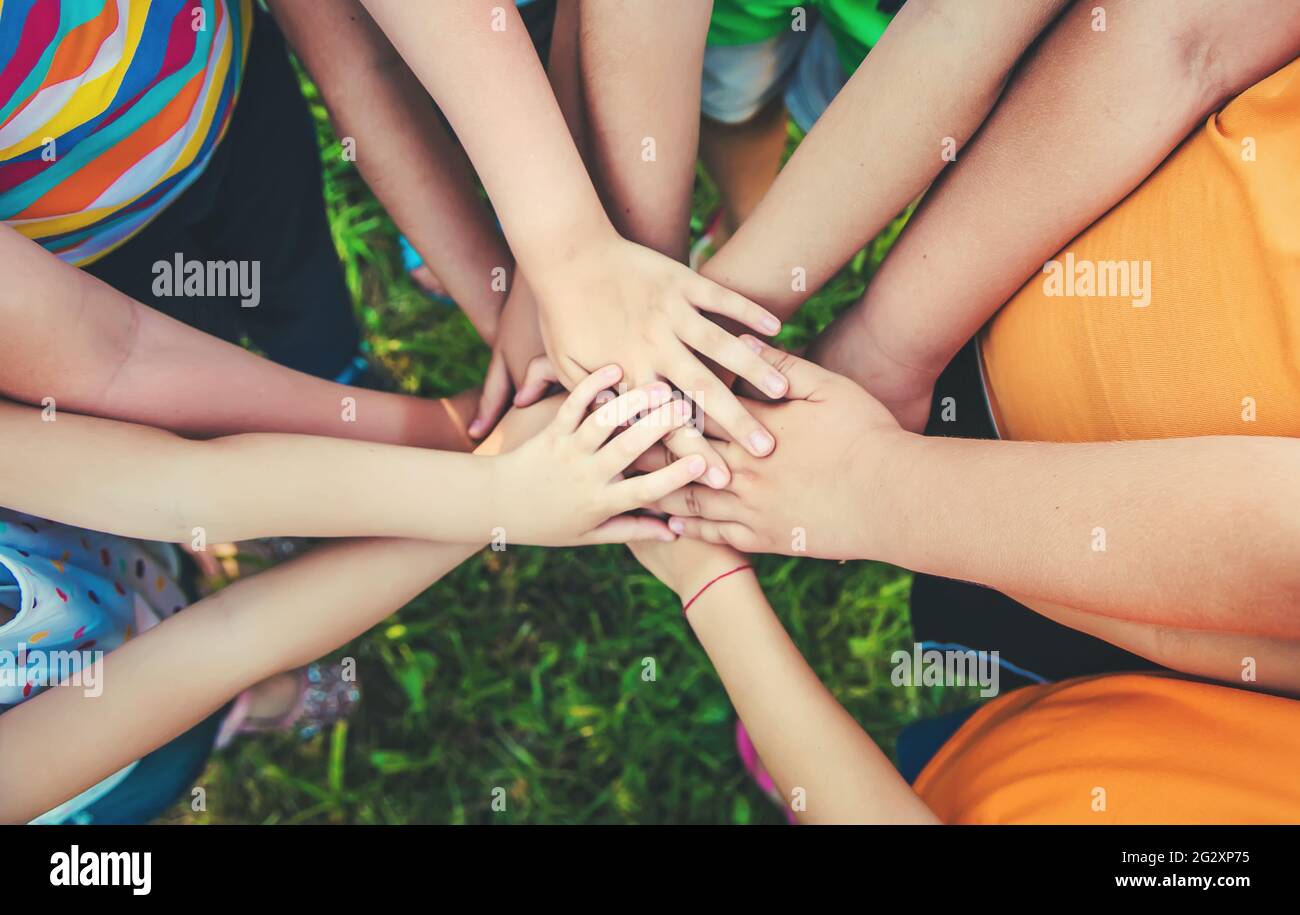 Children are playing with their hands clasped together. Selective focus ...