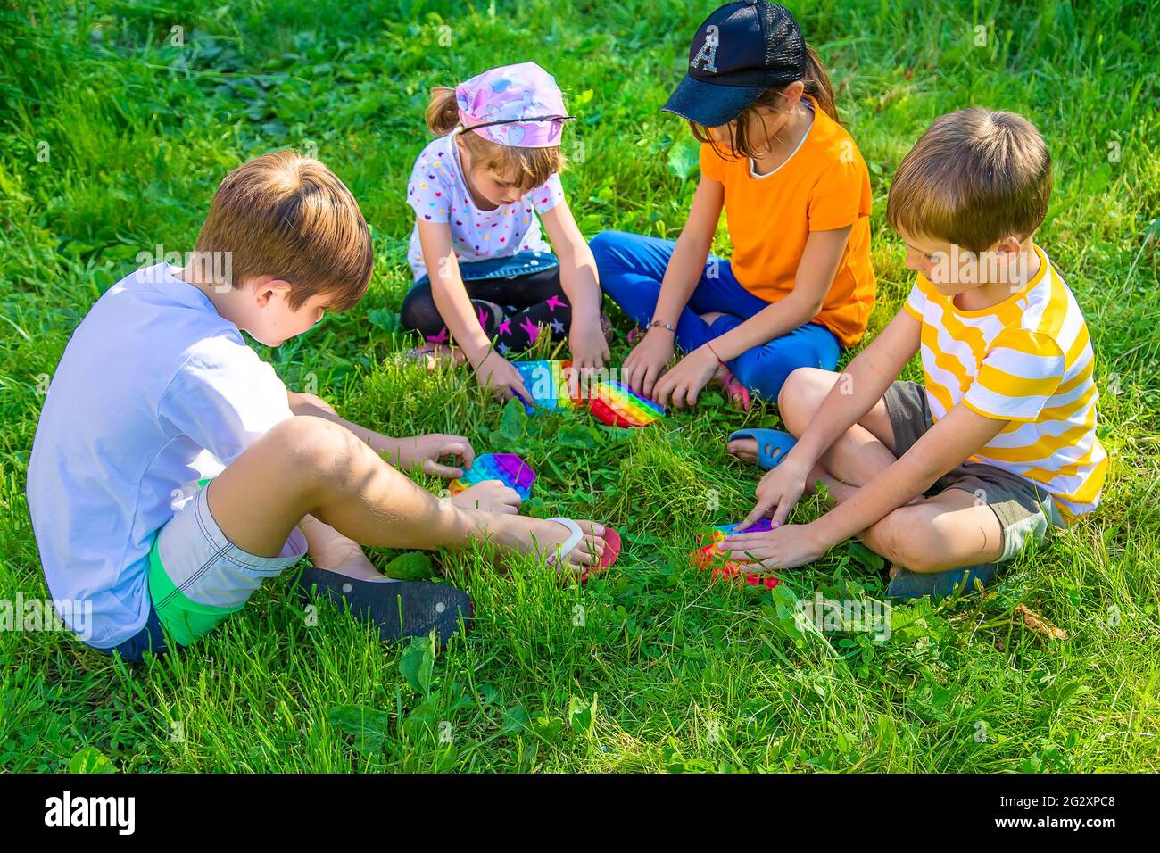 Children play pop it on the street. Selective focus. Kids Stock Photo ...