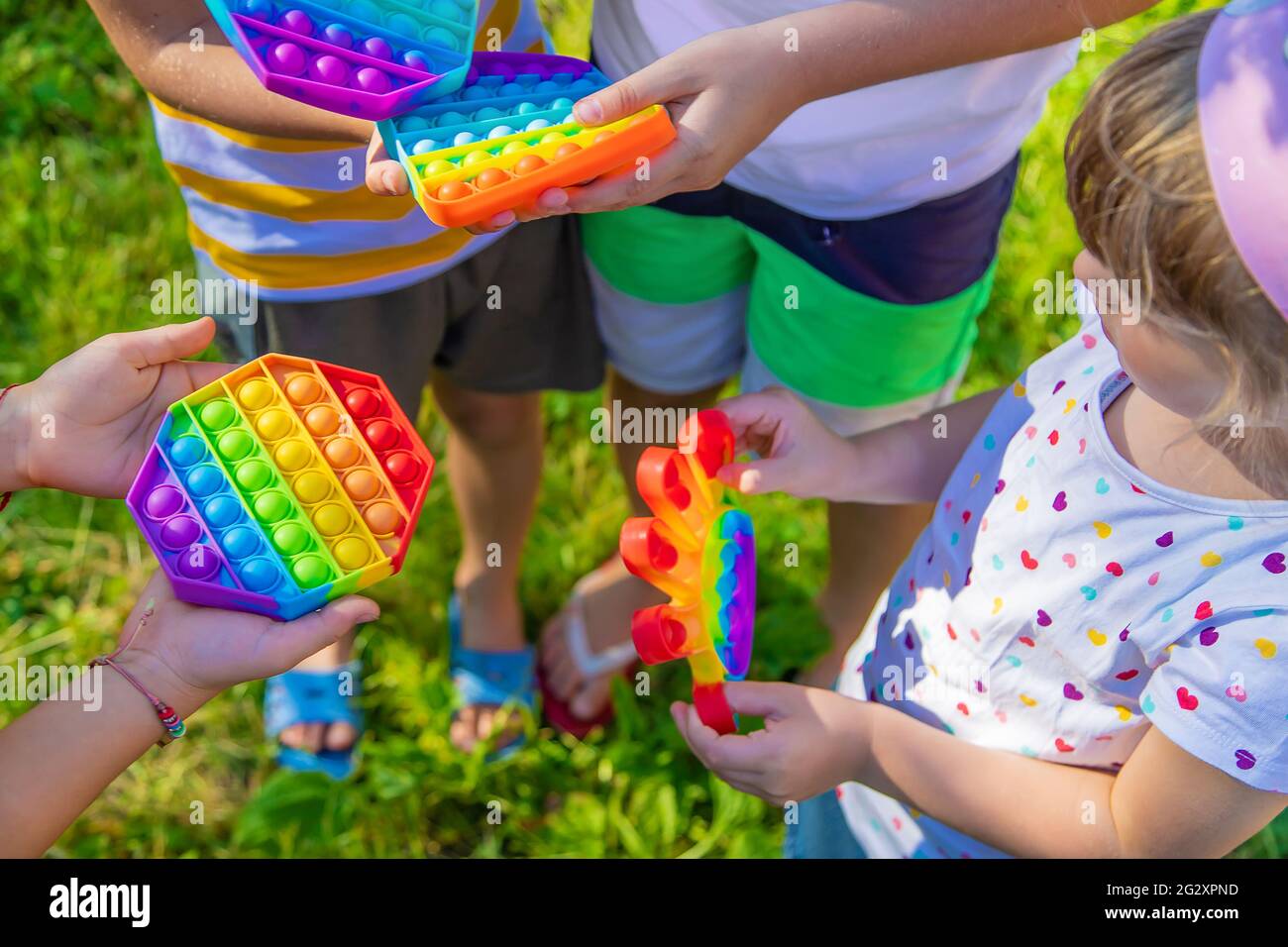 Children play pop it on the street. Selective focus. Kids Stock Photo ...