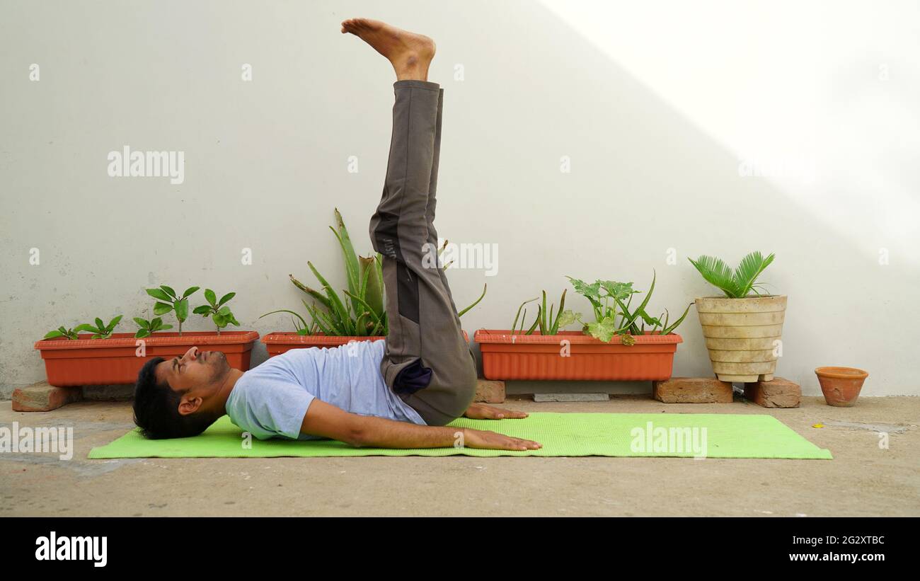 Indian yoga teacher meditating on World Yoga Day. Young man practicing ...