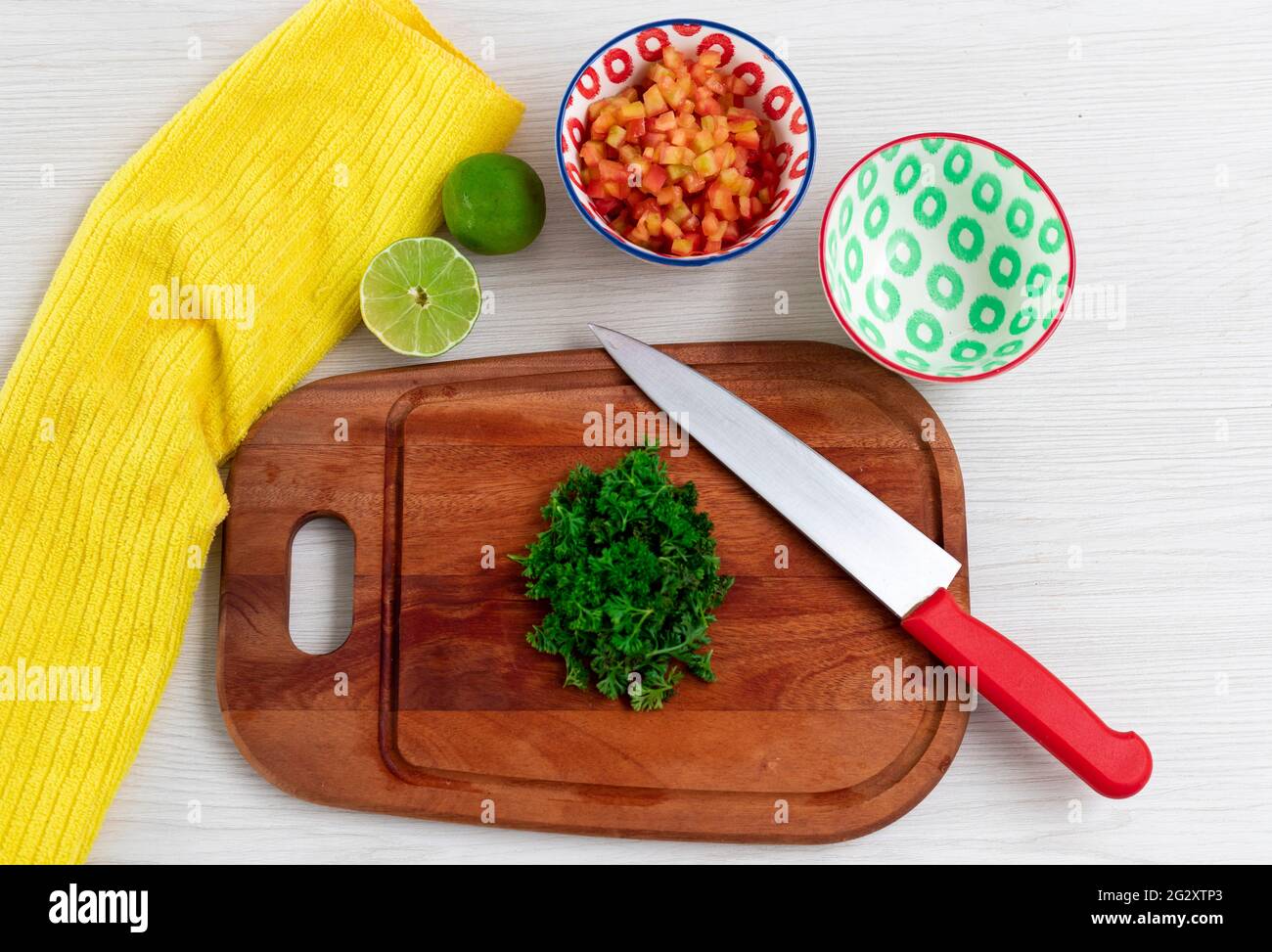 Vegetables with cutting board, tomato concasse, cilantro, lemon, bowls ...