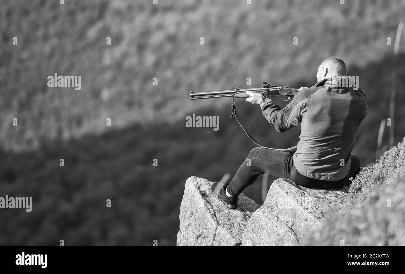 Hunter hold rifle. Hunter spend leisure hunting. Man brutal gamekeeper ...
