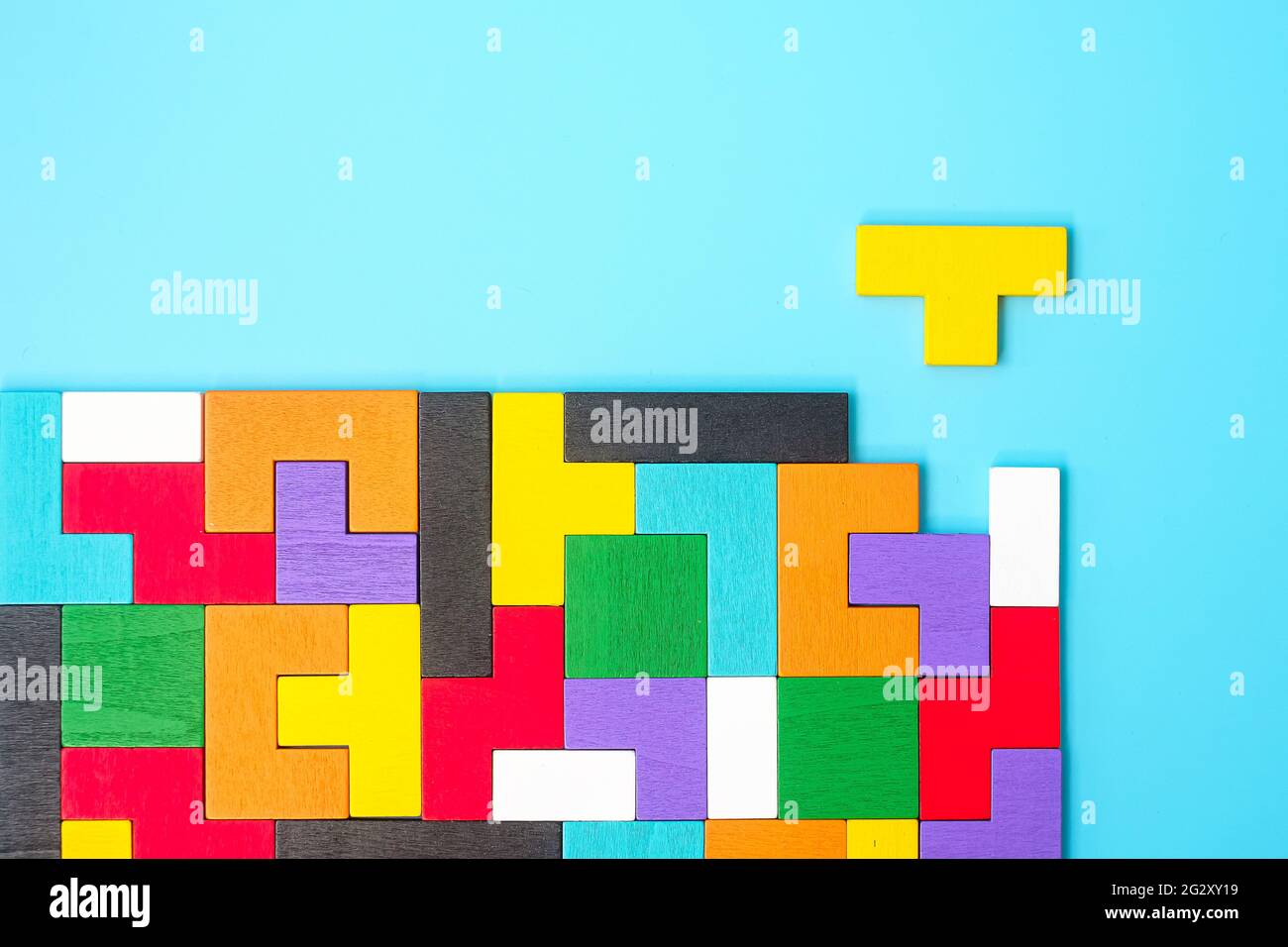colorful wood puzzle pieces on blue background, geometric shape block ...