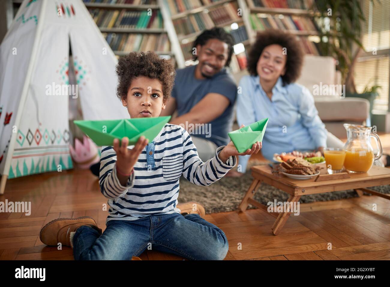 A little boy spending quality time with his parents in a family ...