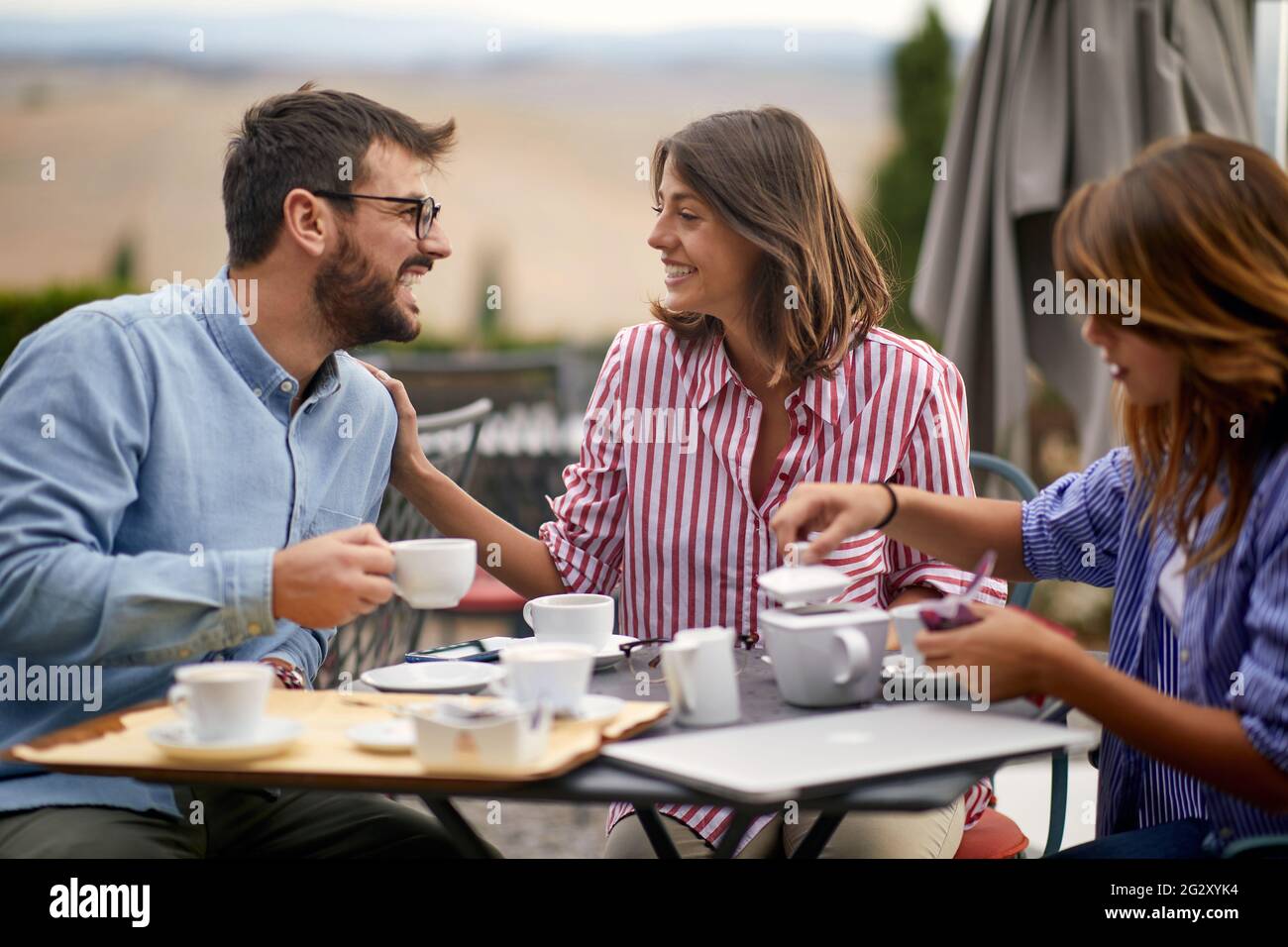 Three friends drinking coffee together in the morning Stock Photo - Alamy