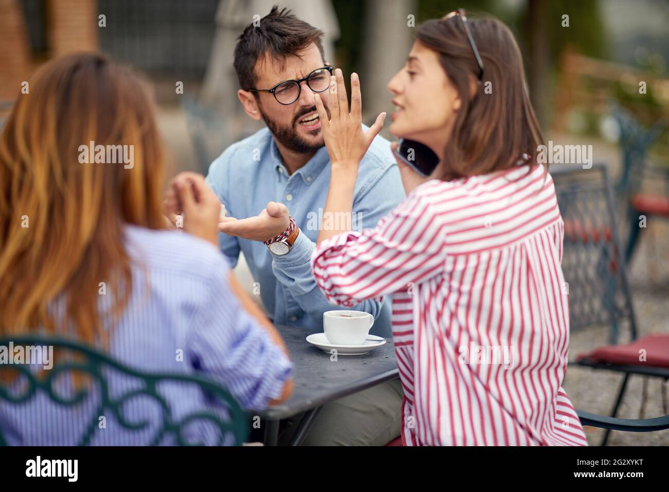 Three students drinking coffee together in the morning Stock Photo - Alamy