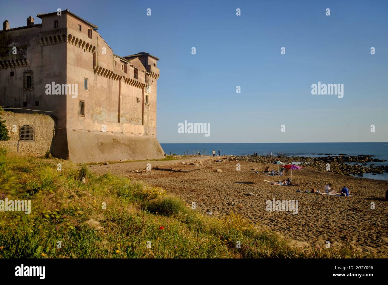 Ancient medieval castle on the beach at summer sunset long exposure ...