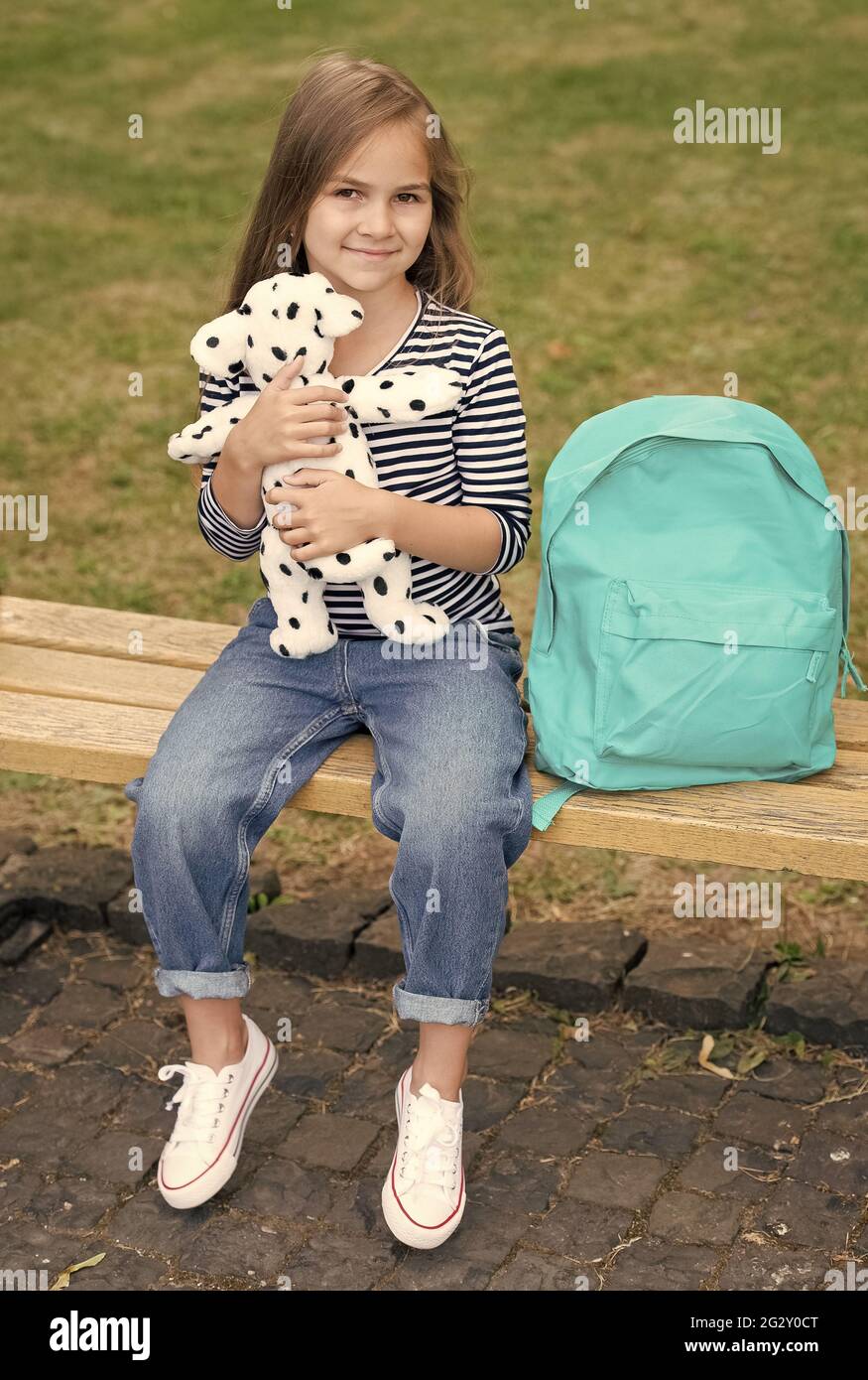 Play, learn and grow. Happy kid play with toy dog outdoors. Child ...