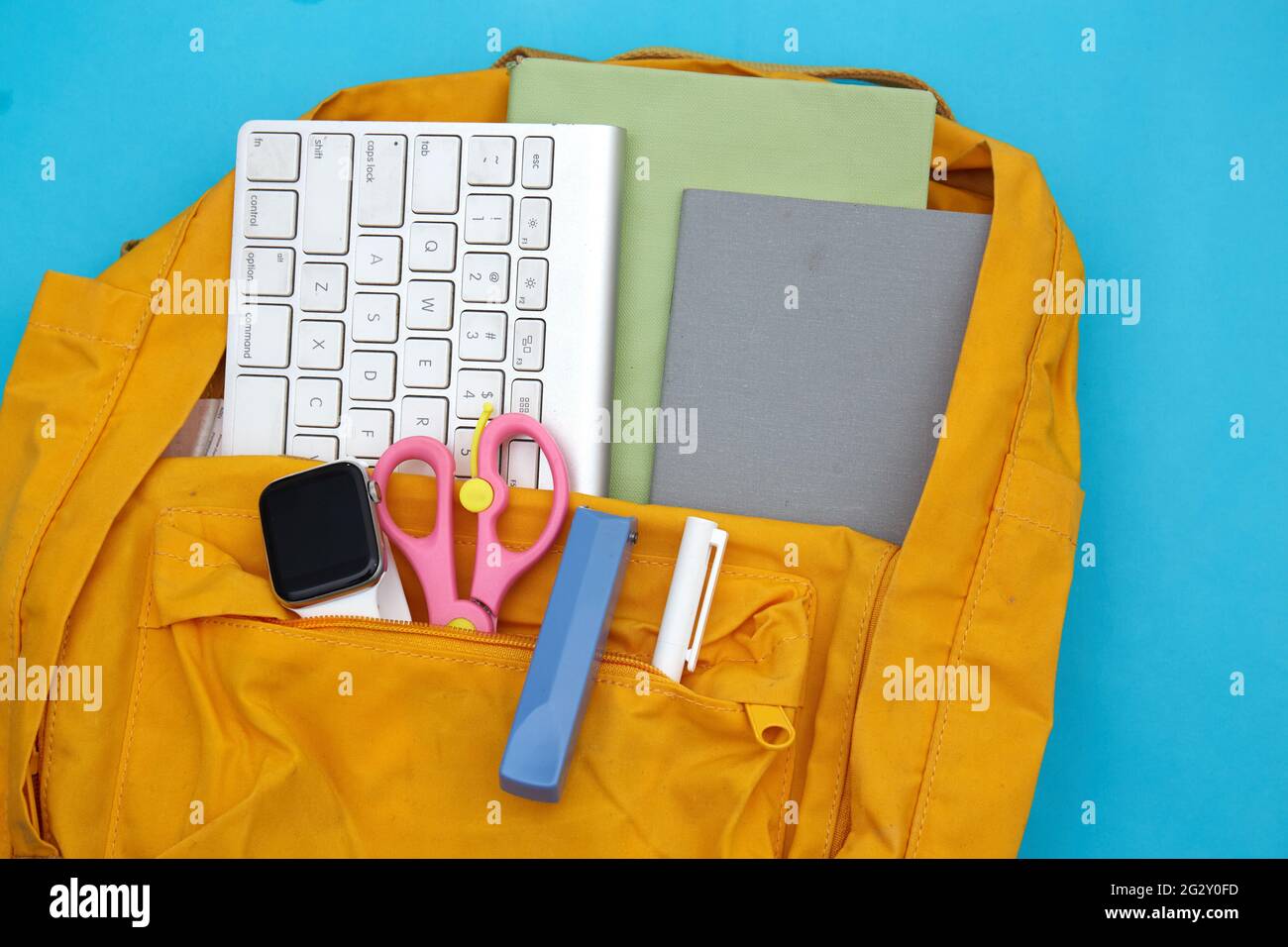 A pen, notepad, and other educational objects on a backpack Stock Photo ...