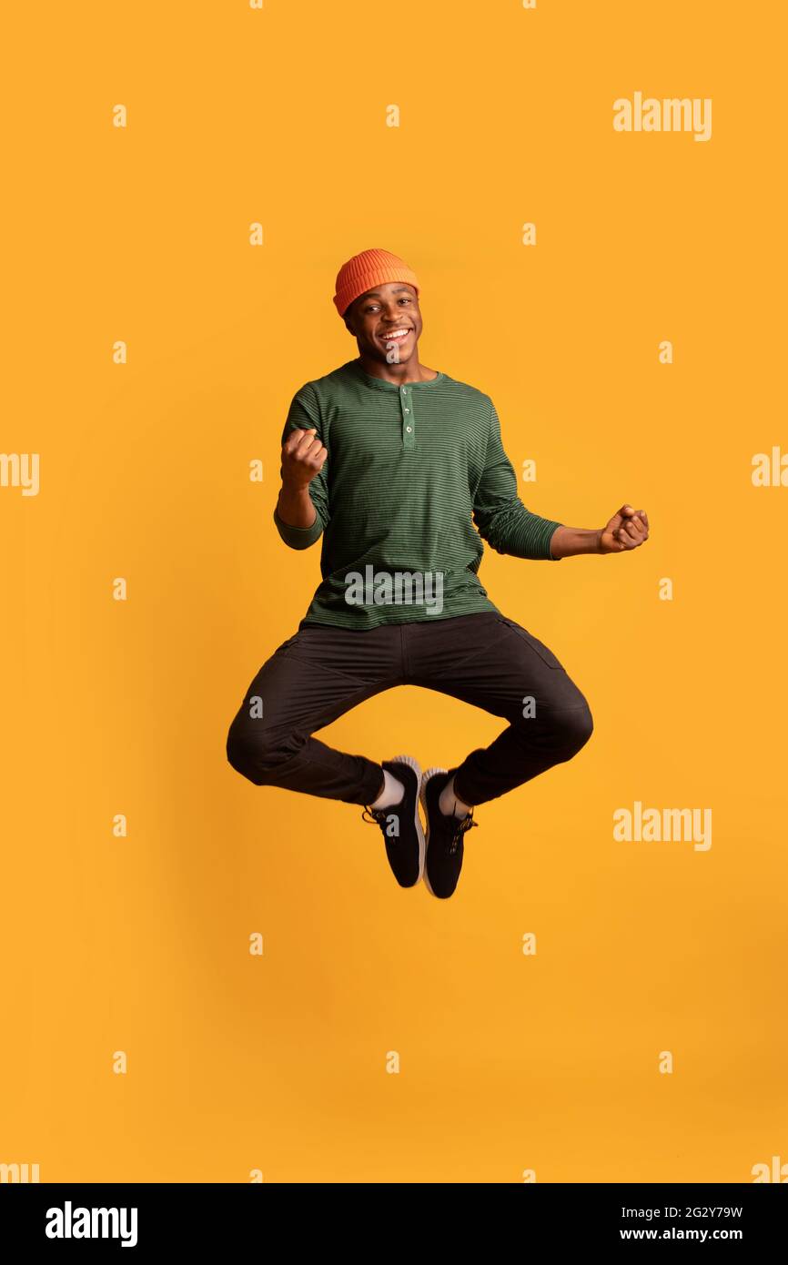 Excited Happy African American Guy Celebrating Success While Jumping In ...