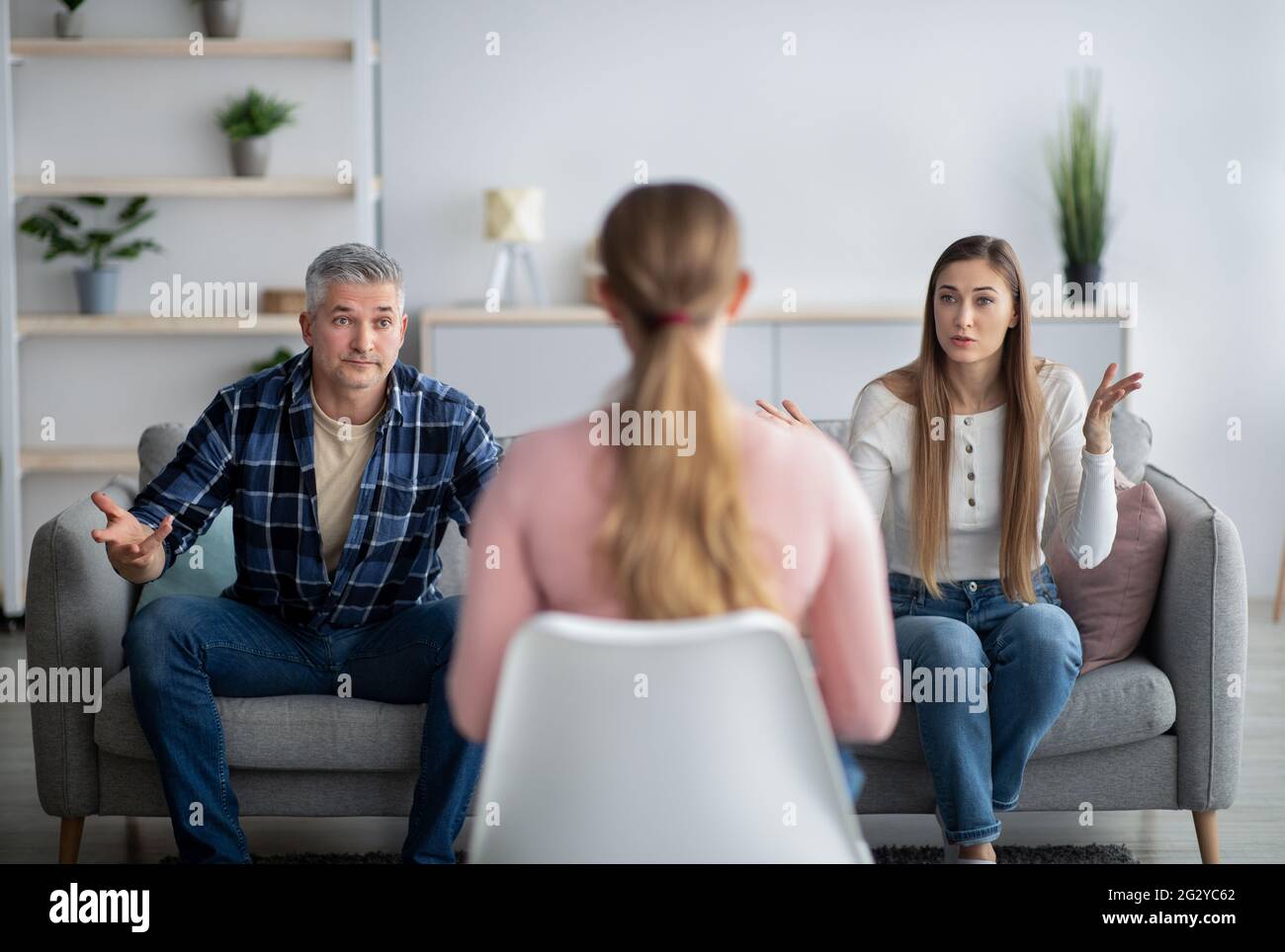 Mature couple having argument at psychologist's office, matiral ...