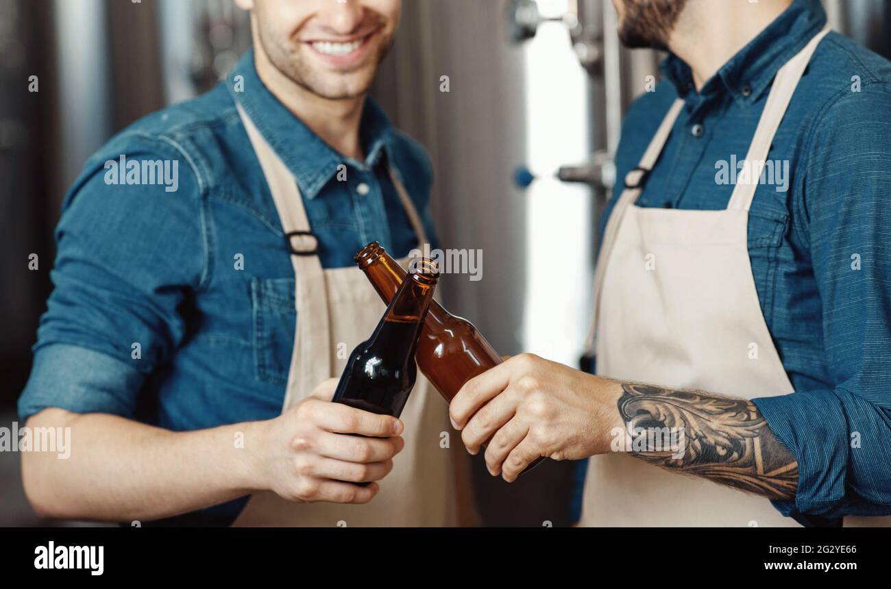 Professional brewers owners taste new drink at brewery Stock Photo - Alamy
