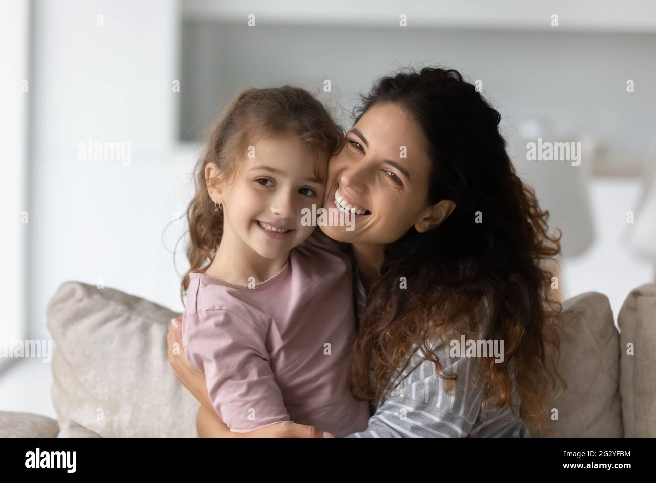 Happy Hispanic mom and daughter hug at home Stock Photo - Alamy