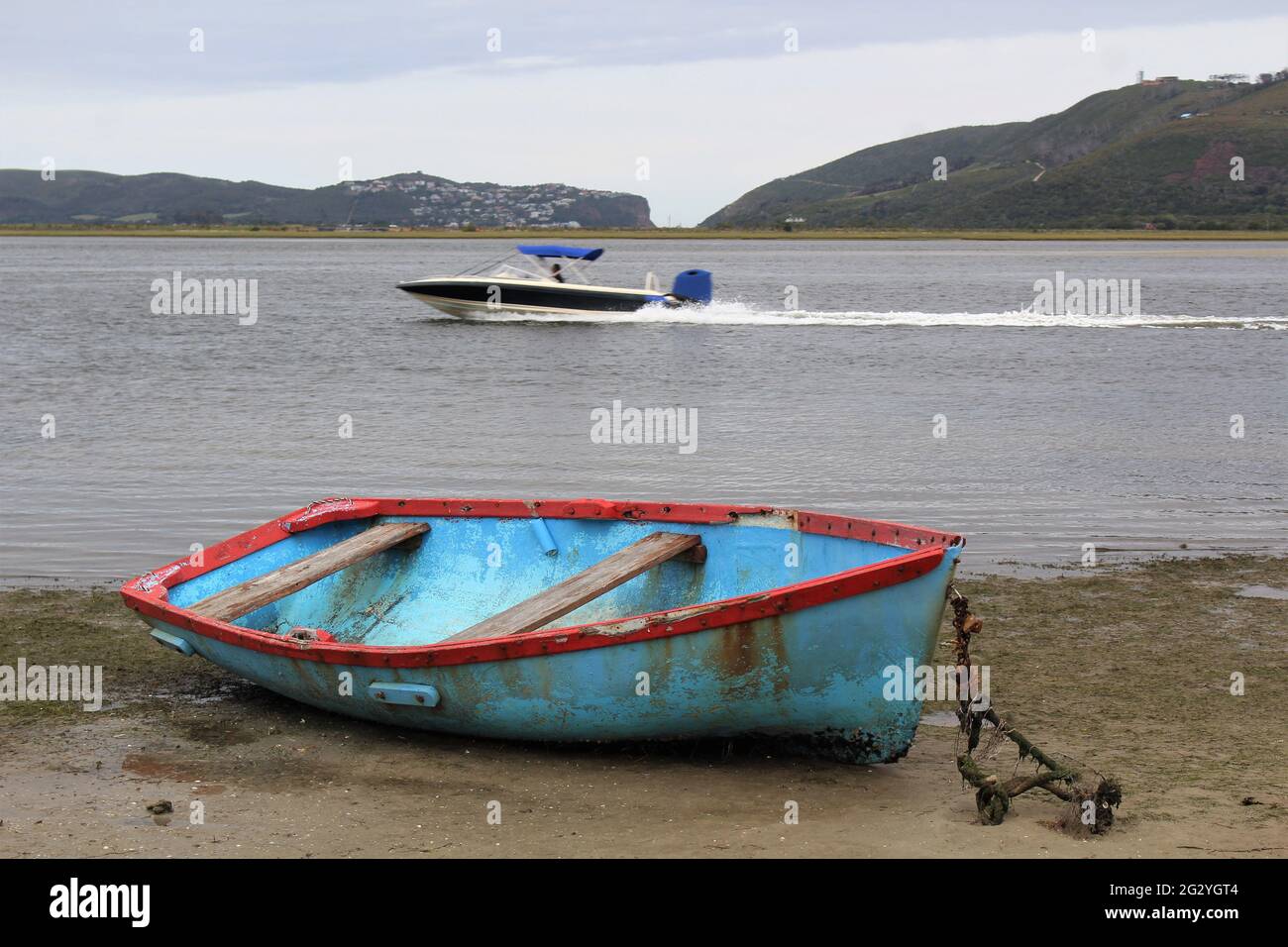 Empty boats at a seaside during low tide in KNysna Stock Photo - Alamy