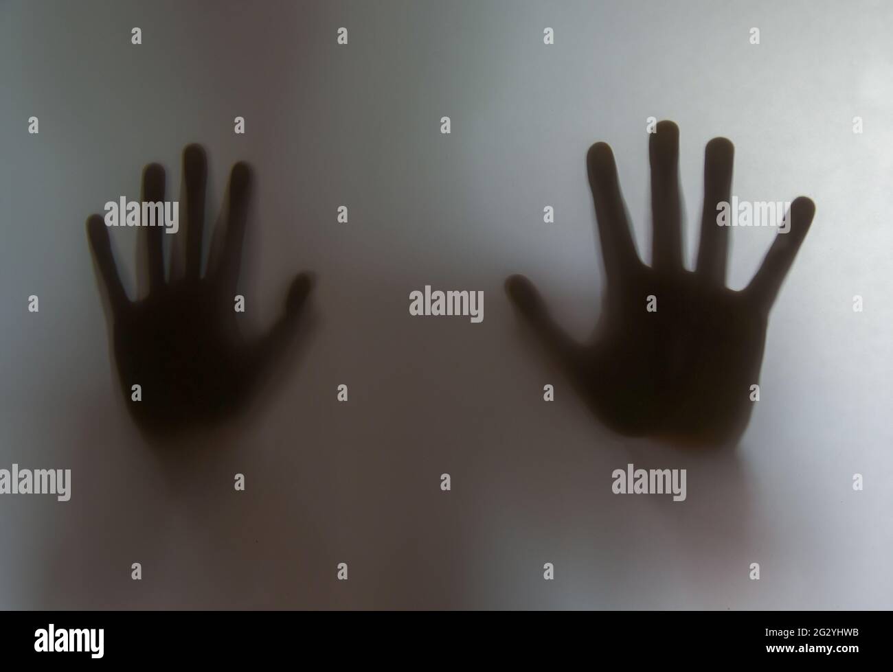 Reflection of shadows of children hands on frosted glass, blur Stock ...