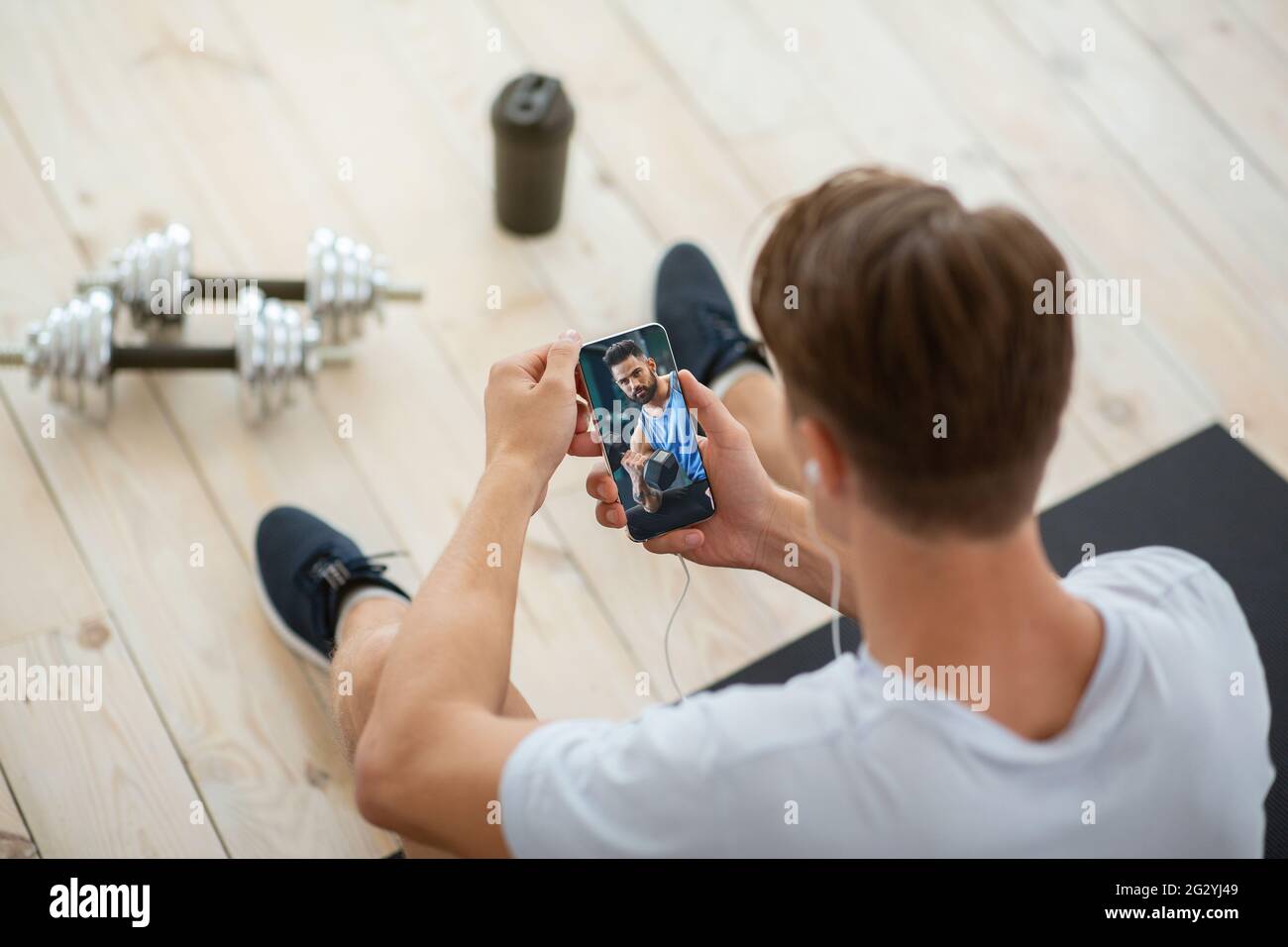 Online coach for home workout. Unrecognizable young guy watching ...