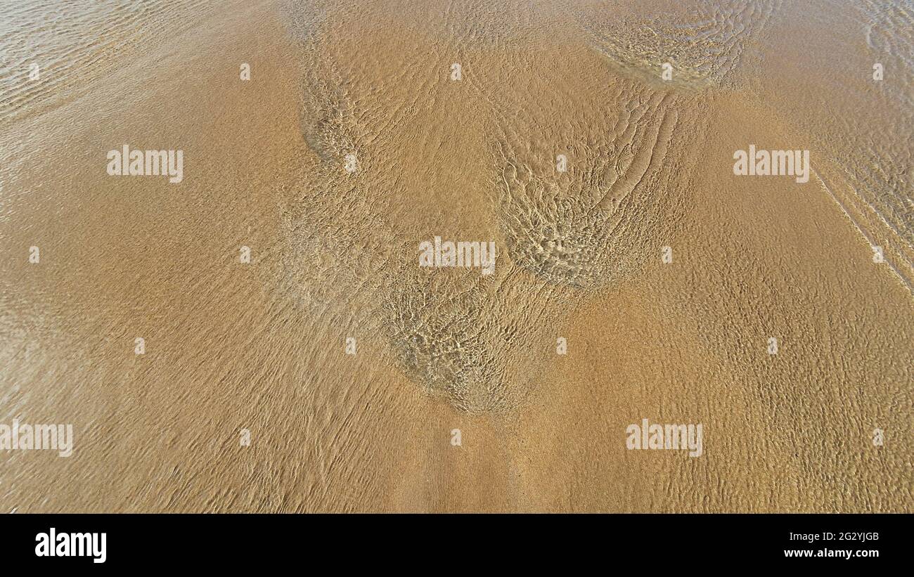 Sand and water: patterns and lines in sand created by the and water ...