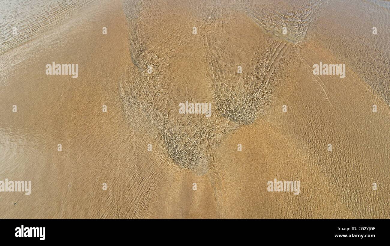 Sand and water: patterns and lines in sand created by the and water ...