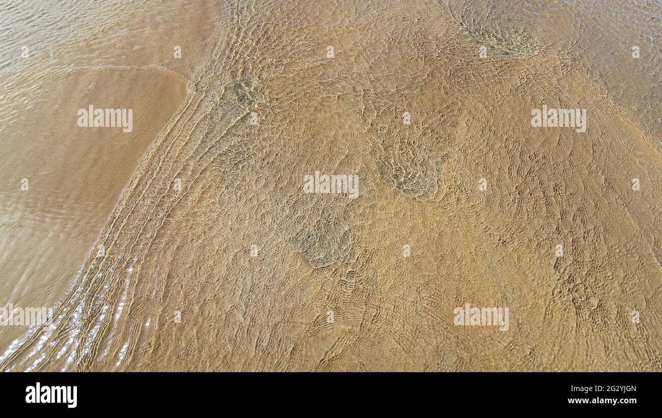 Sand and water: patterns and lines in sand created by the and water ...
