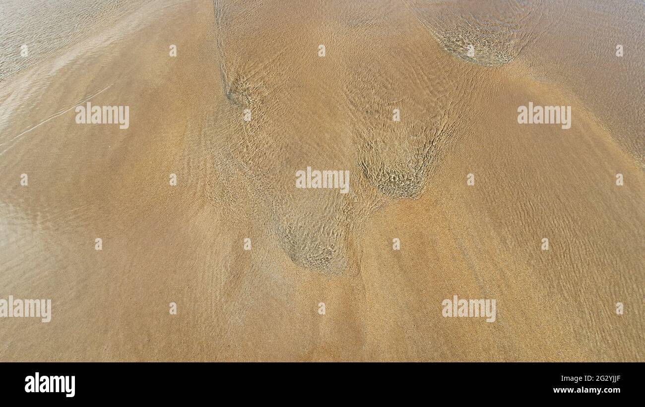 Sand and water: patterns and lines in sand created by the and water ...