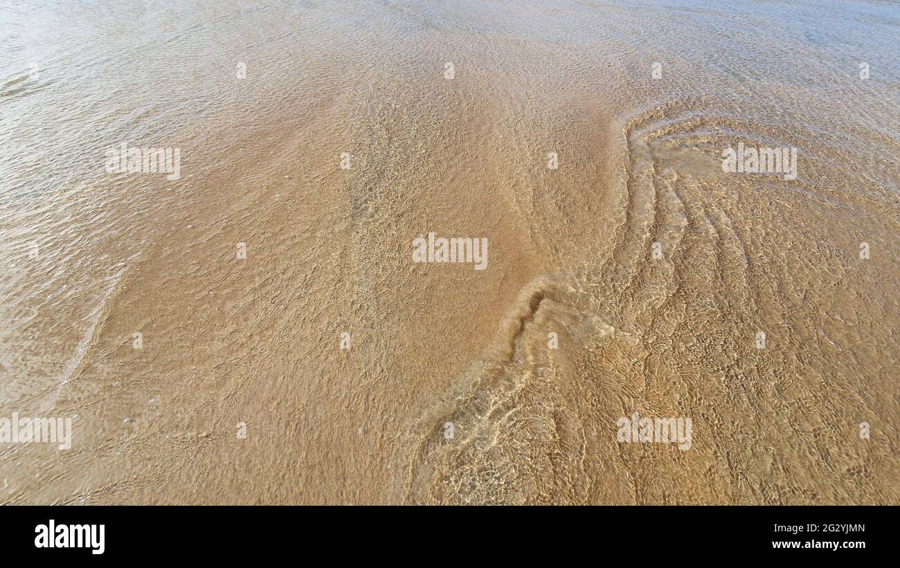 Sand and water: patterns and lines in sand created by the and water ...