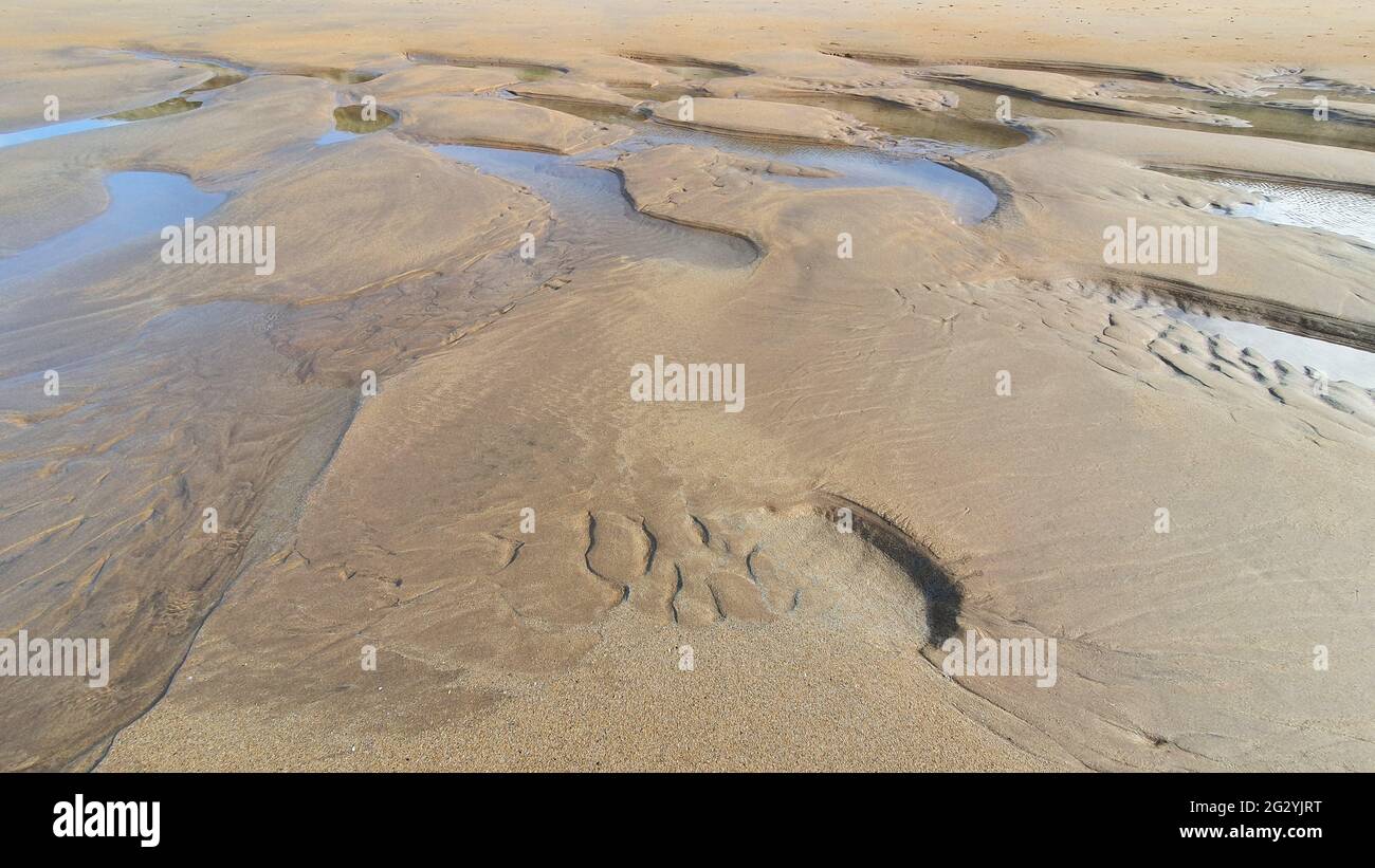 Sand and water: patterns and lines in sand created by the and water ...