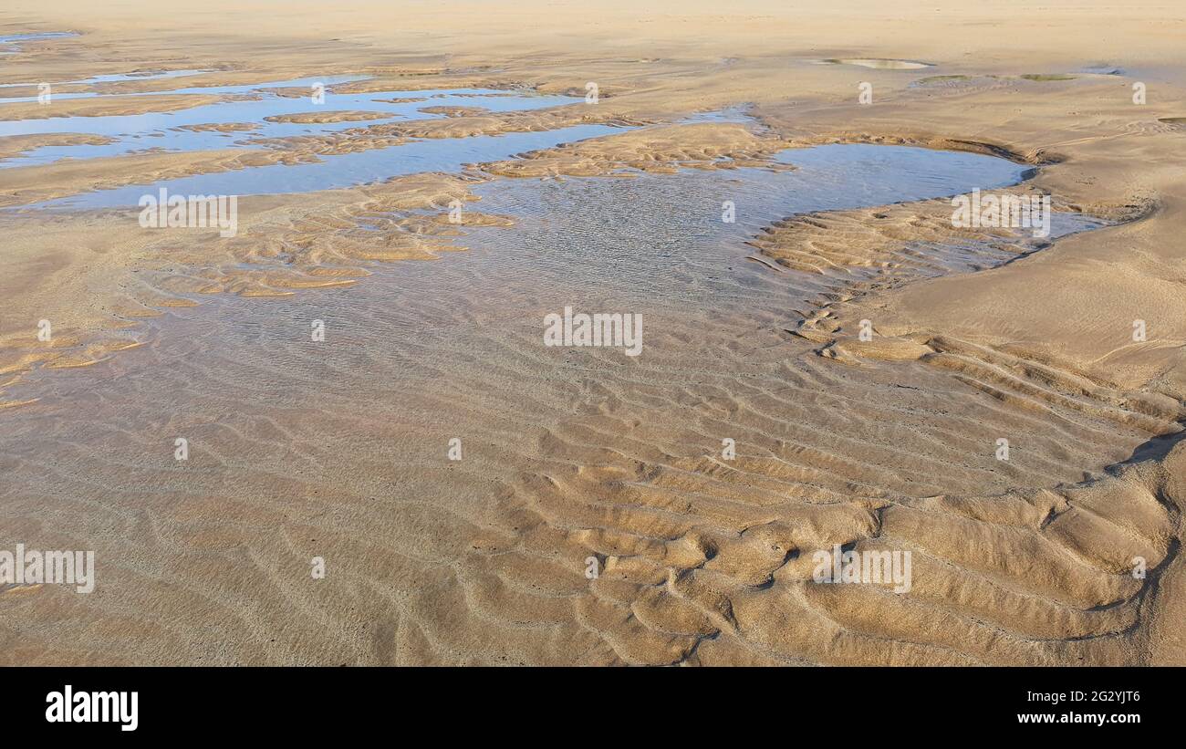 Sand and water: patterns and lines in sand created by the and water ...