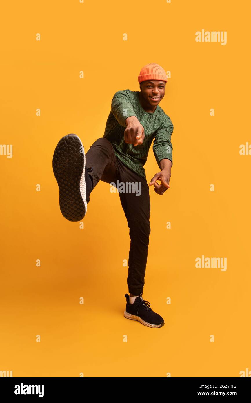 Gotcha. Handsome black smiling hipster guy pointing fingers at camera ...