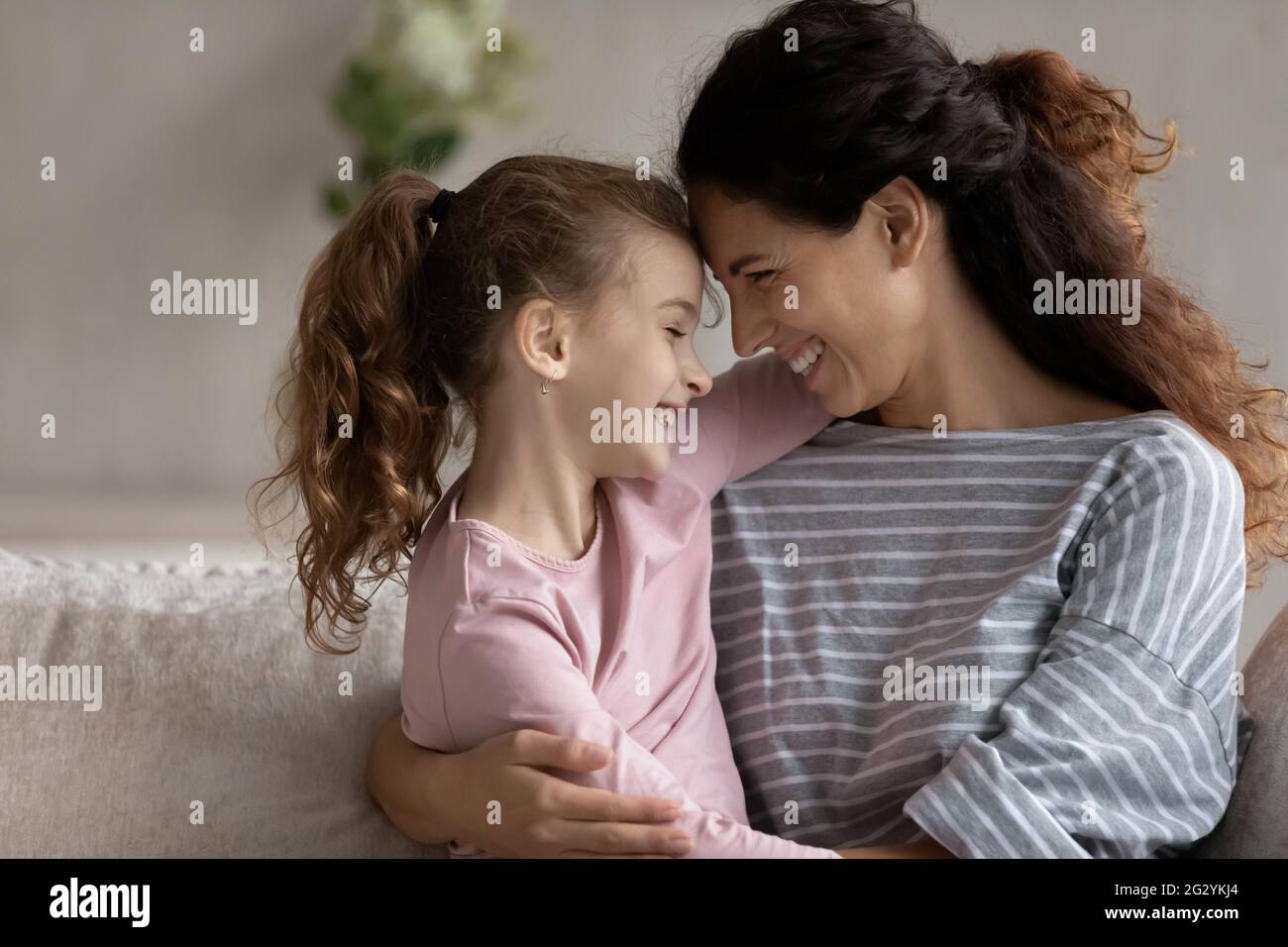 Happy Hispanic mom and little daughter hug at home Stock Photo - Alamy
