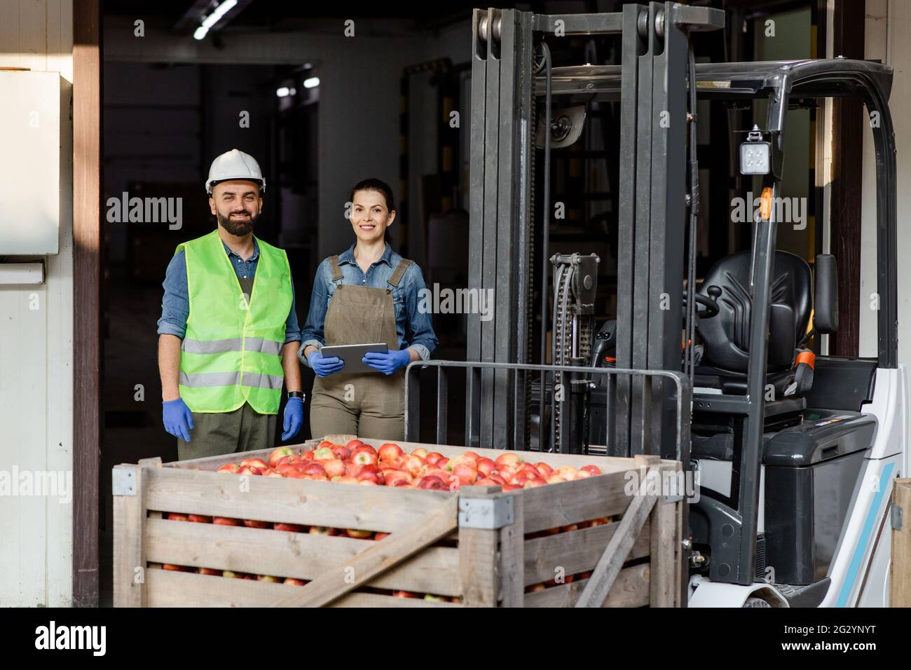 Forklift truck loading with full containers. Fruits and food ...