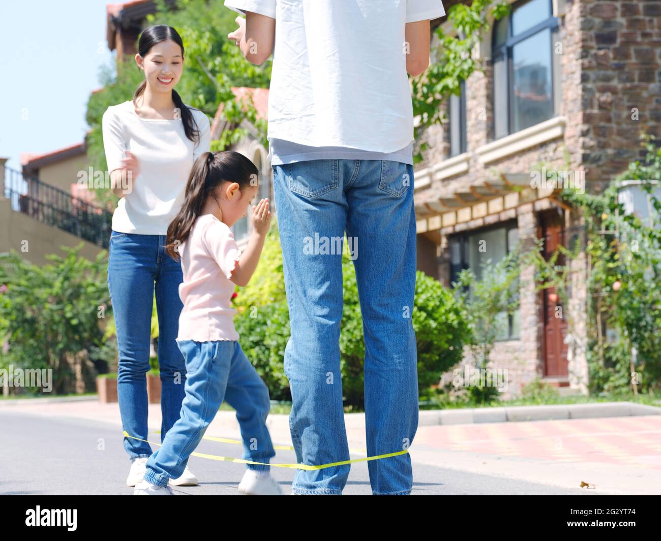 A happy family of three skipping rope outdoors high quality photo Stock ...
