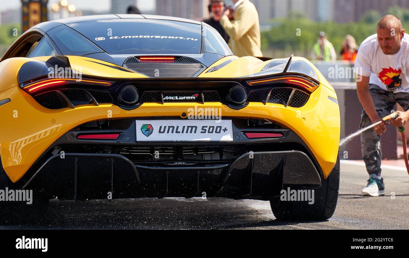 Technicians prepare the yellow McLaren 765 wheels before the race.On ...