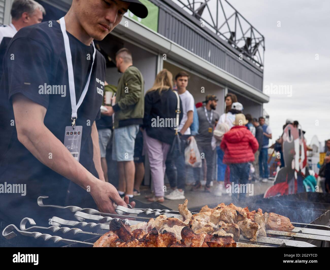 A man prepares barbecue for the festival visitors.On June 5 and 6 at ...