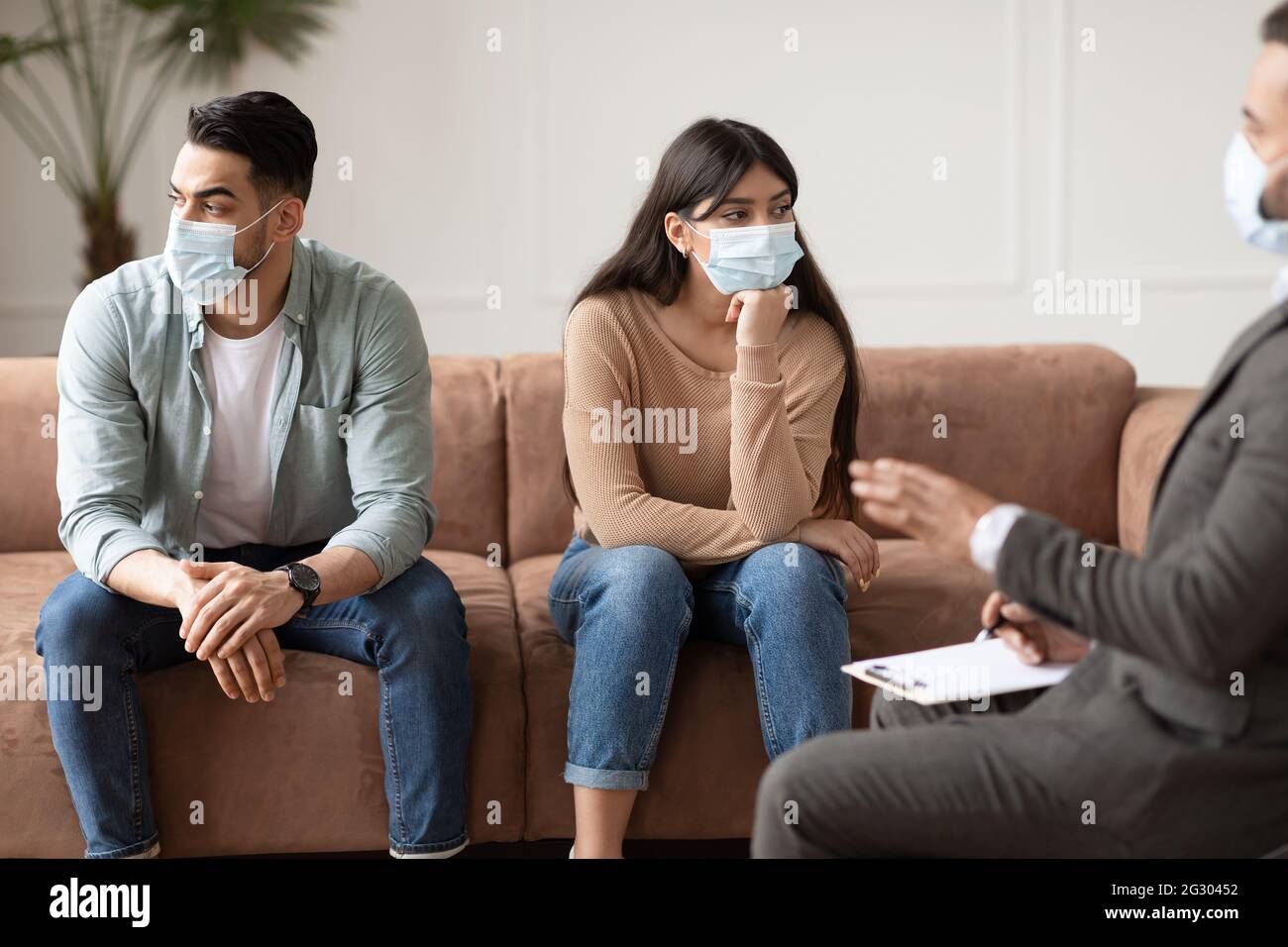 Sad couple sitting at therapy session in therapists office Stock Photo ...