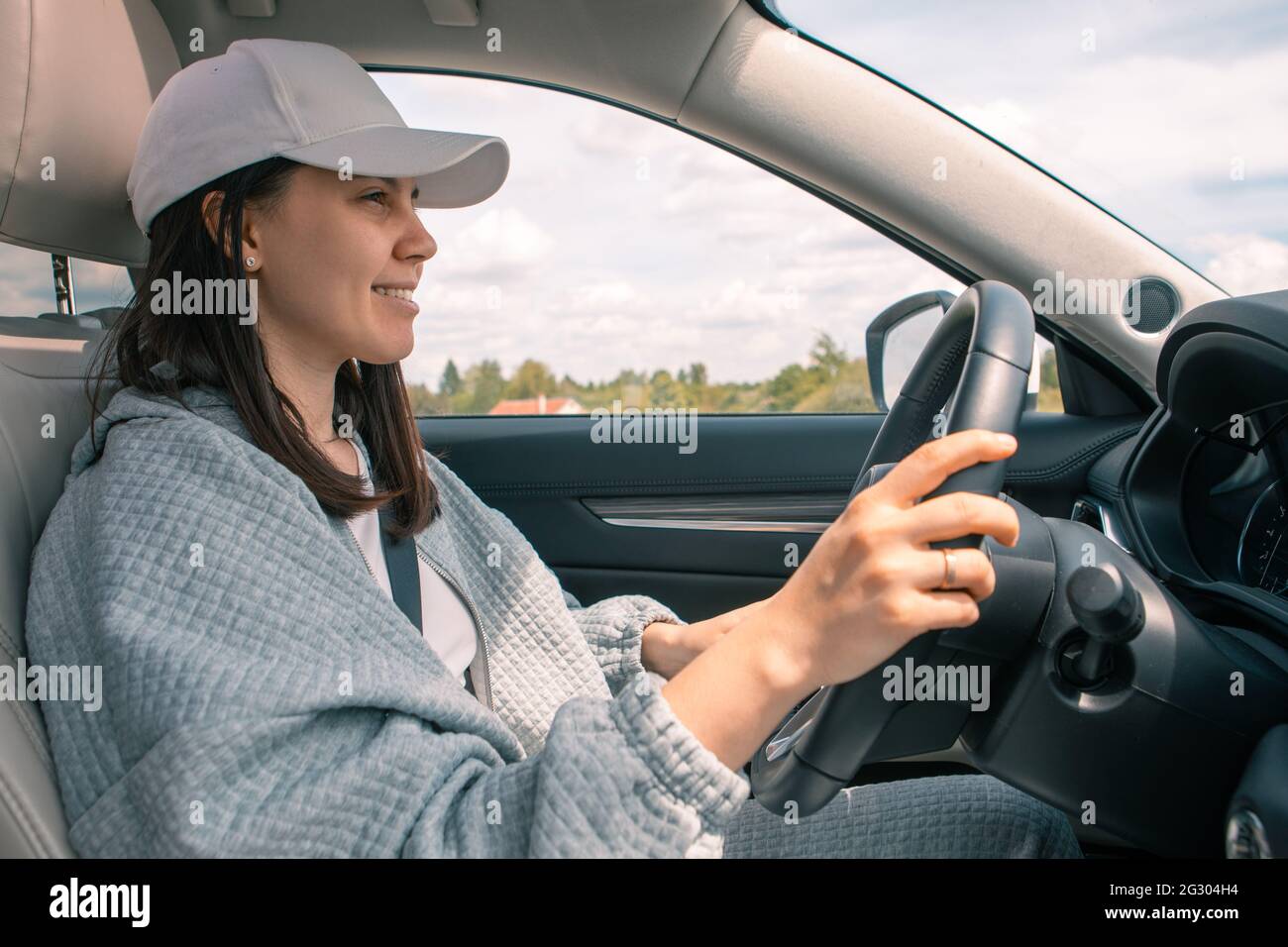 smiling woman driving car view from inside copy space Stock Photo - Alamy